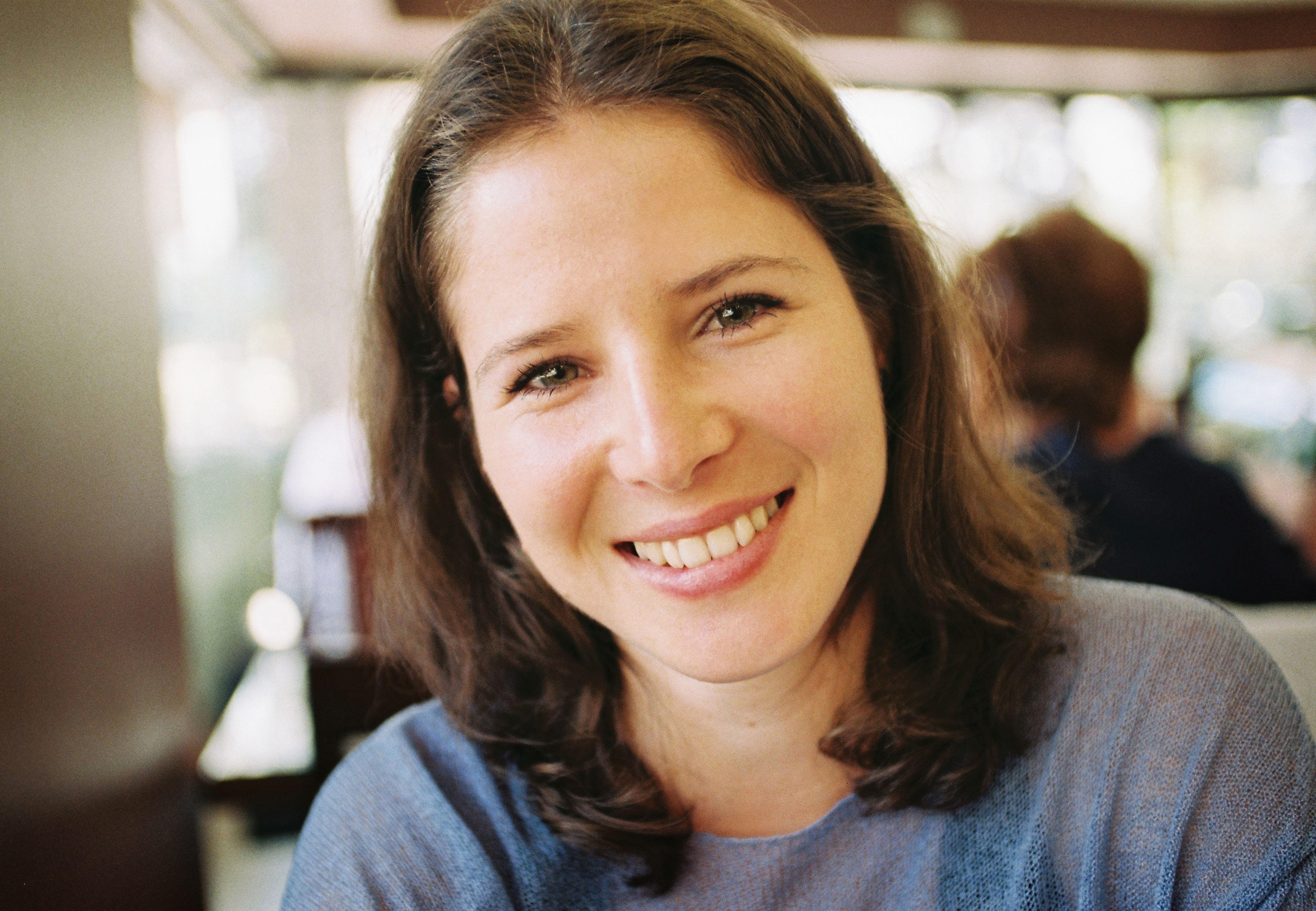 Candid Portrait of Smiling Woman in Café · Free Stock Photo