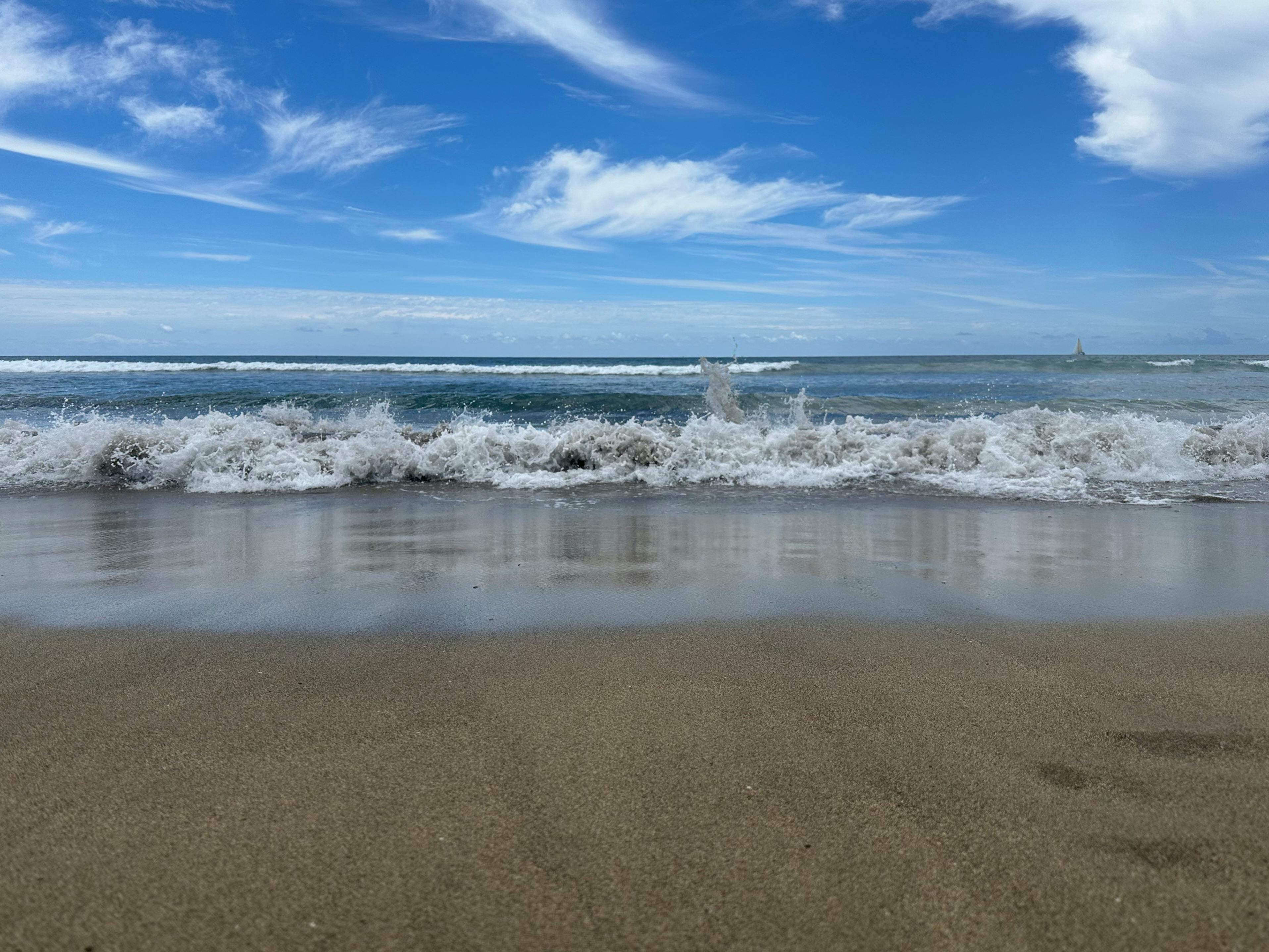 Sunny Beach with Splashing Waves and Blue Sky · Free Stock Photo