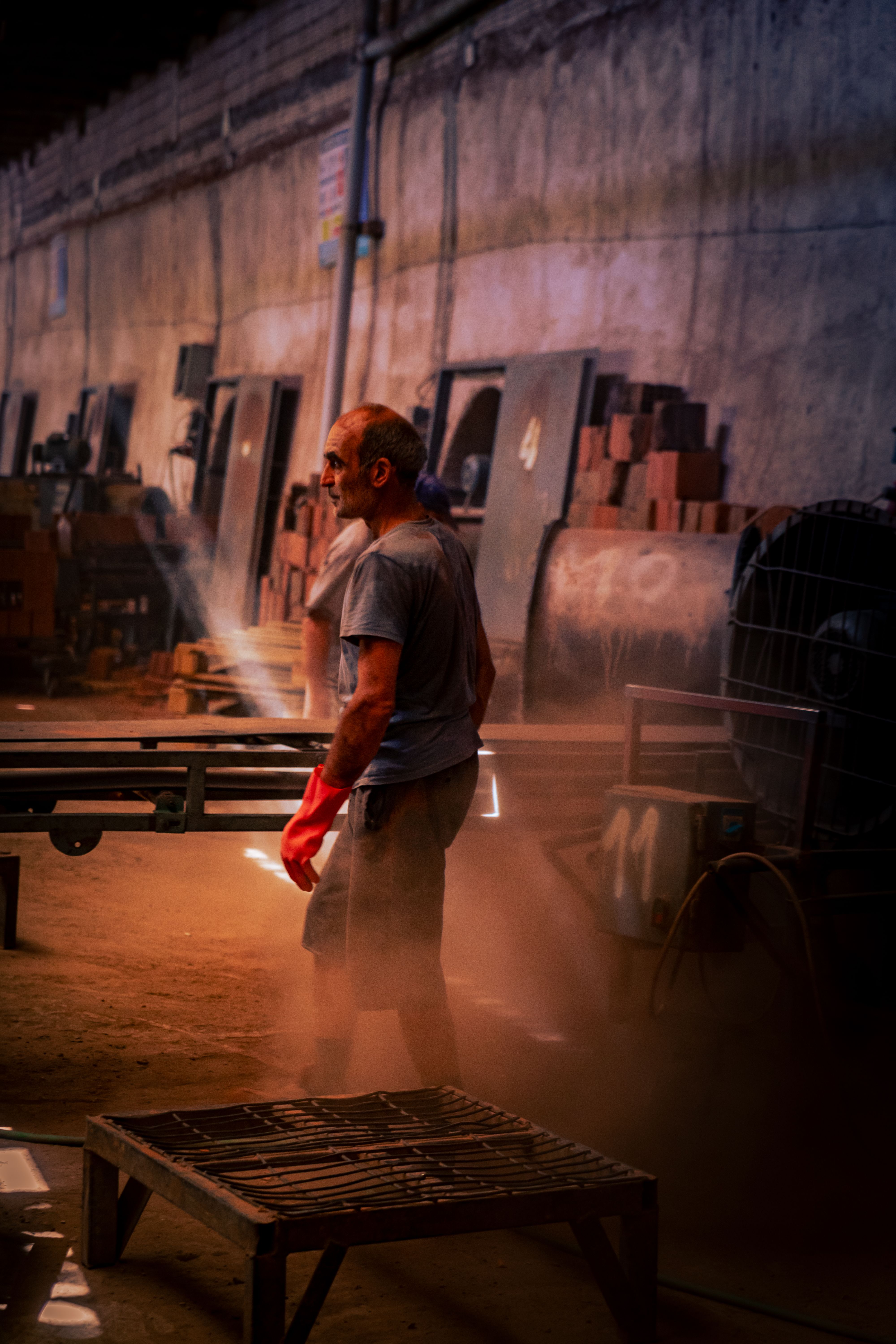Industrial Worker in Dusty Warehouse · Free Stock Photo