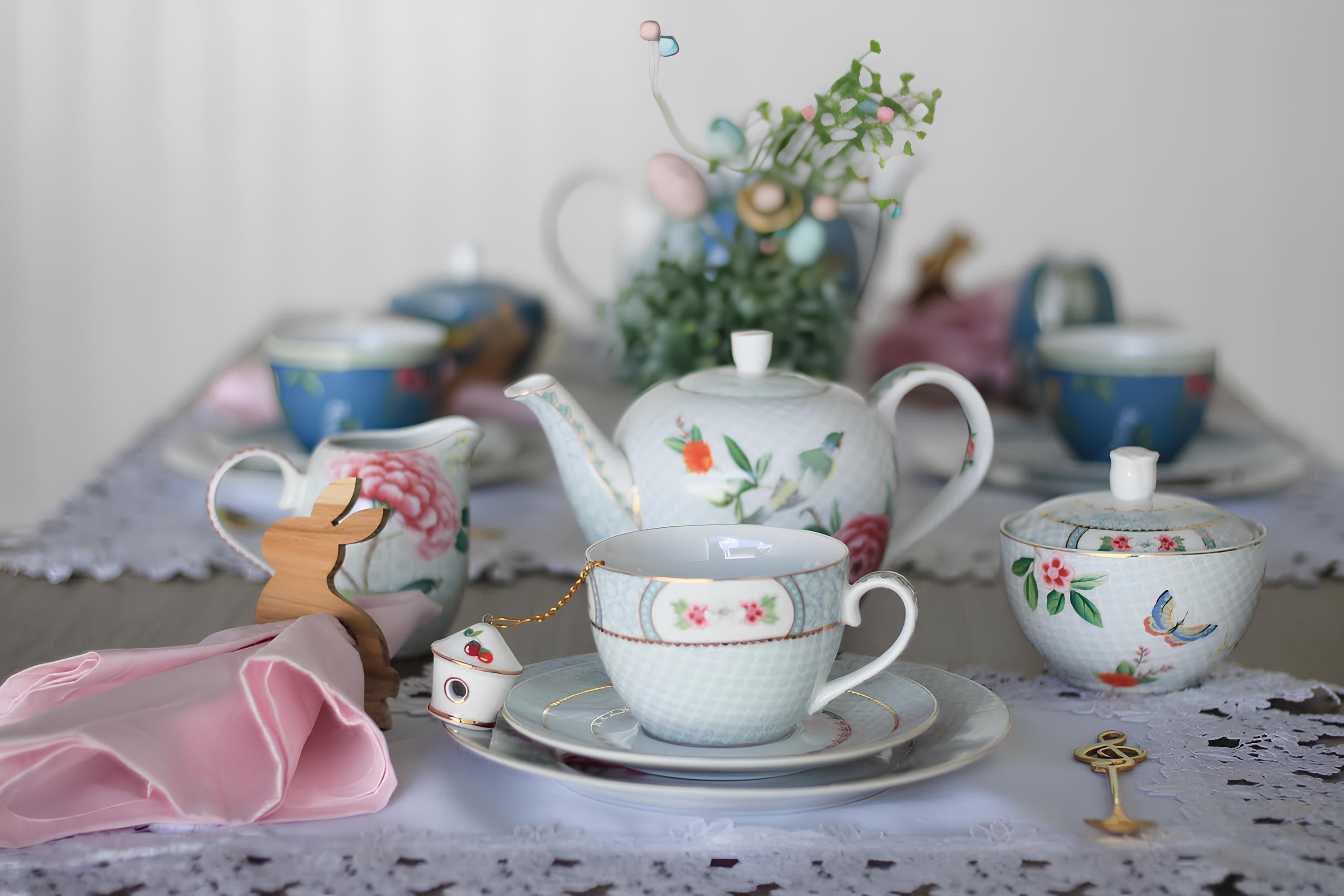 Elegant Tea Set on Decorated Table with Floral Design · Free Stock Photo