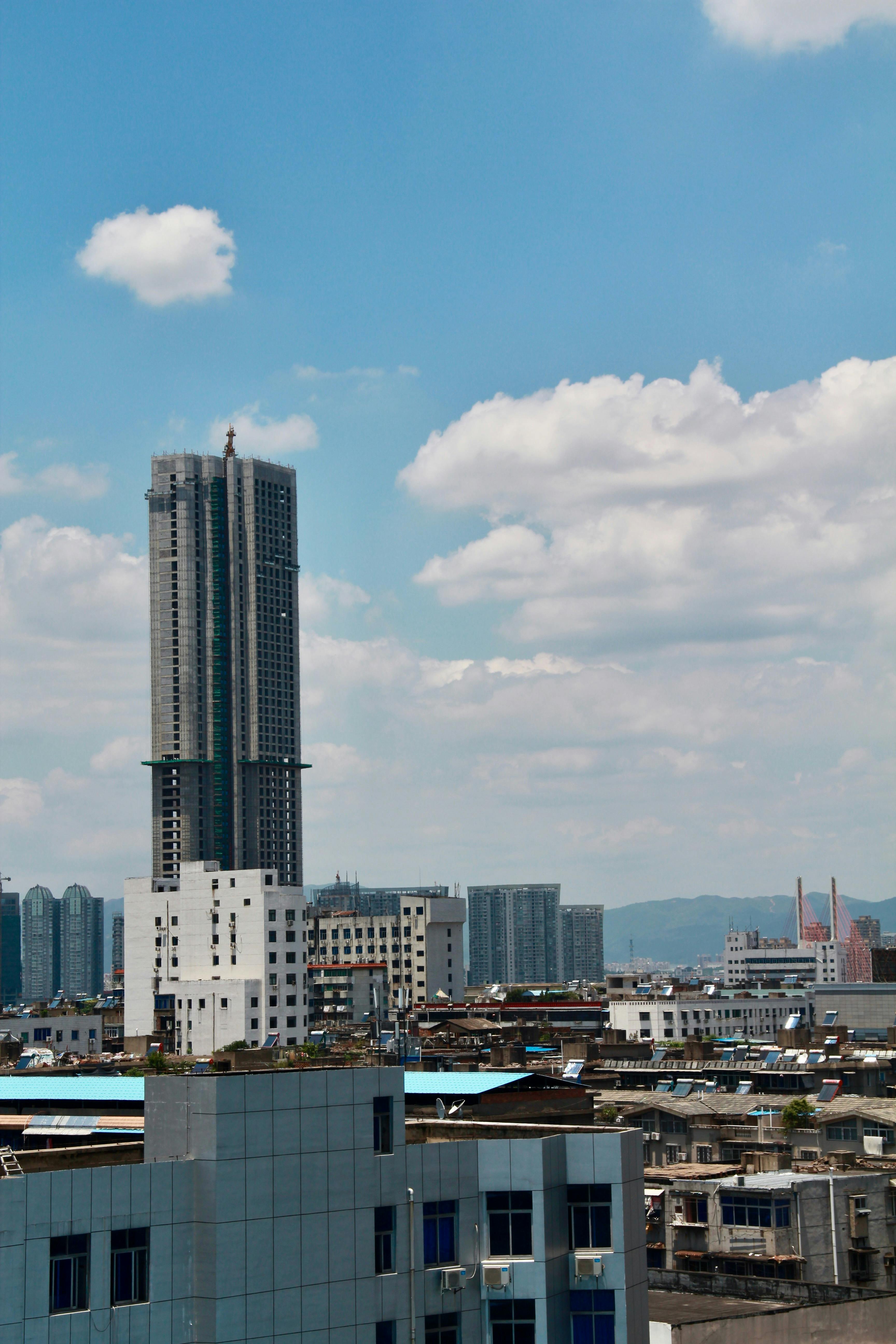 Tall Skyscraper against Blue Sky in Urban Landscape · Free Stock Photo