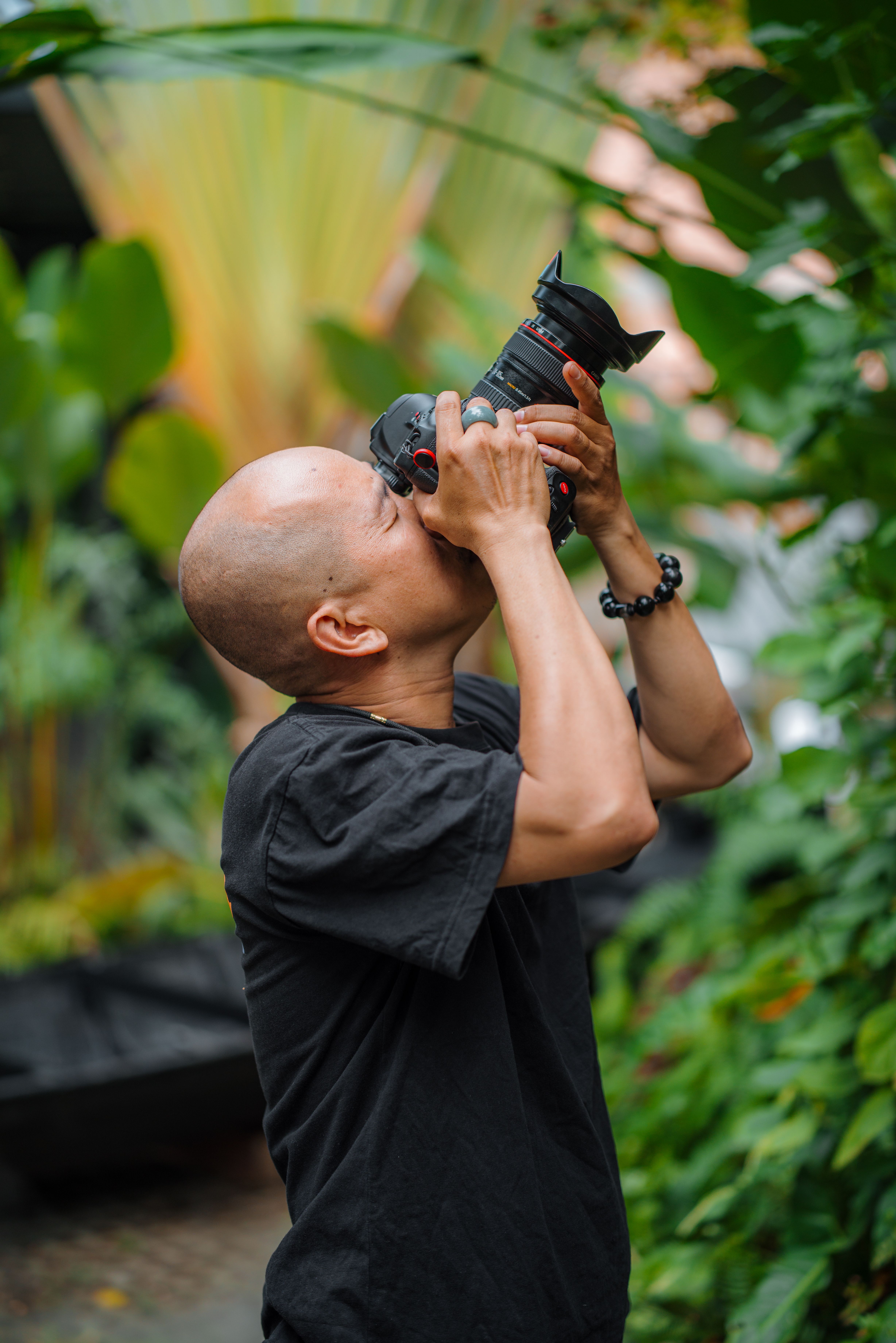 Photographer Capturing Nature with a DSLR Camera · Free Stock Photo