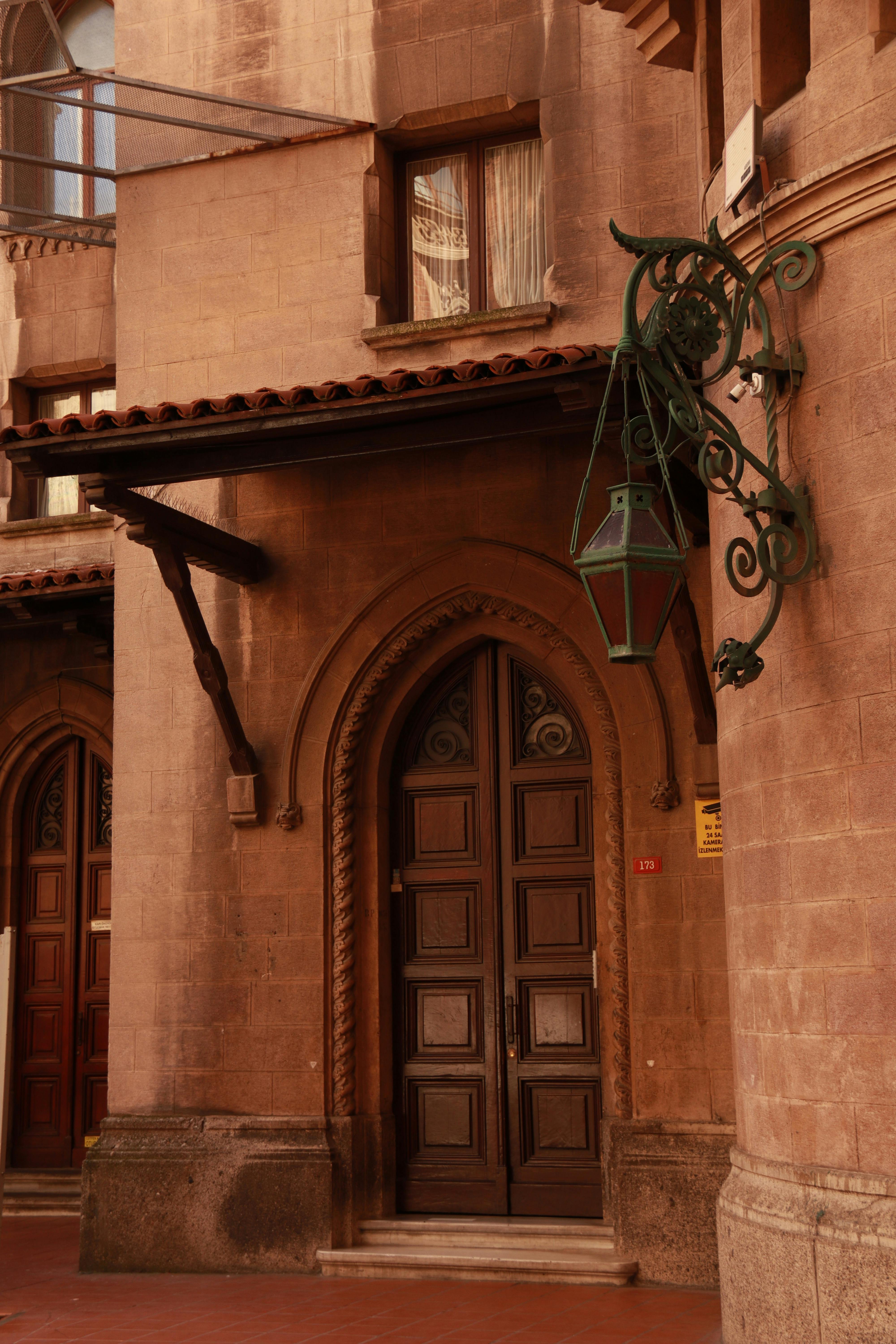 Rustic European Archway with Ornate Lantern · Free Stock Photo