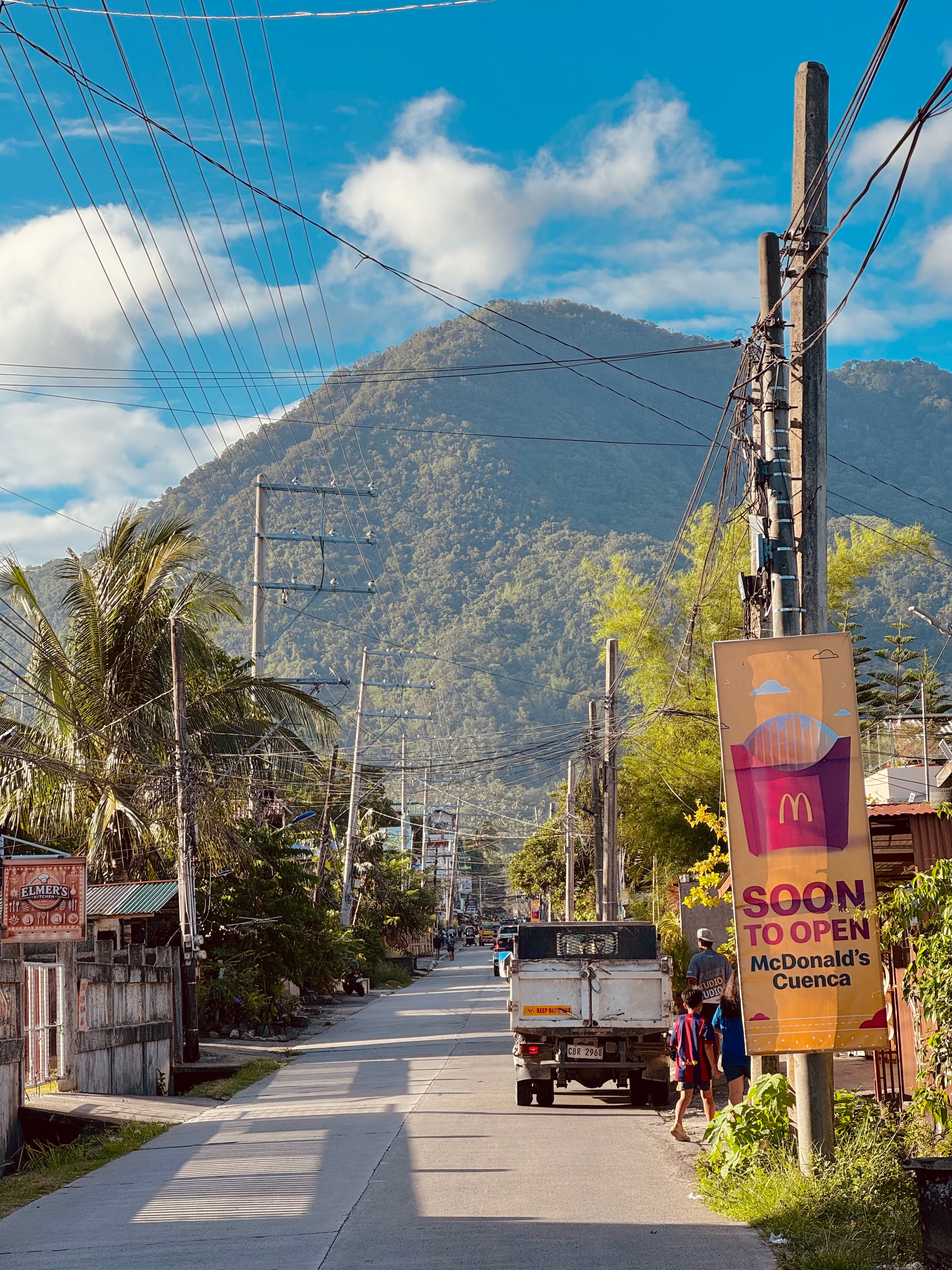 Scenic Street View with Mountain and Signage · Free Stock Photo