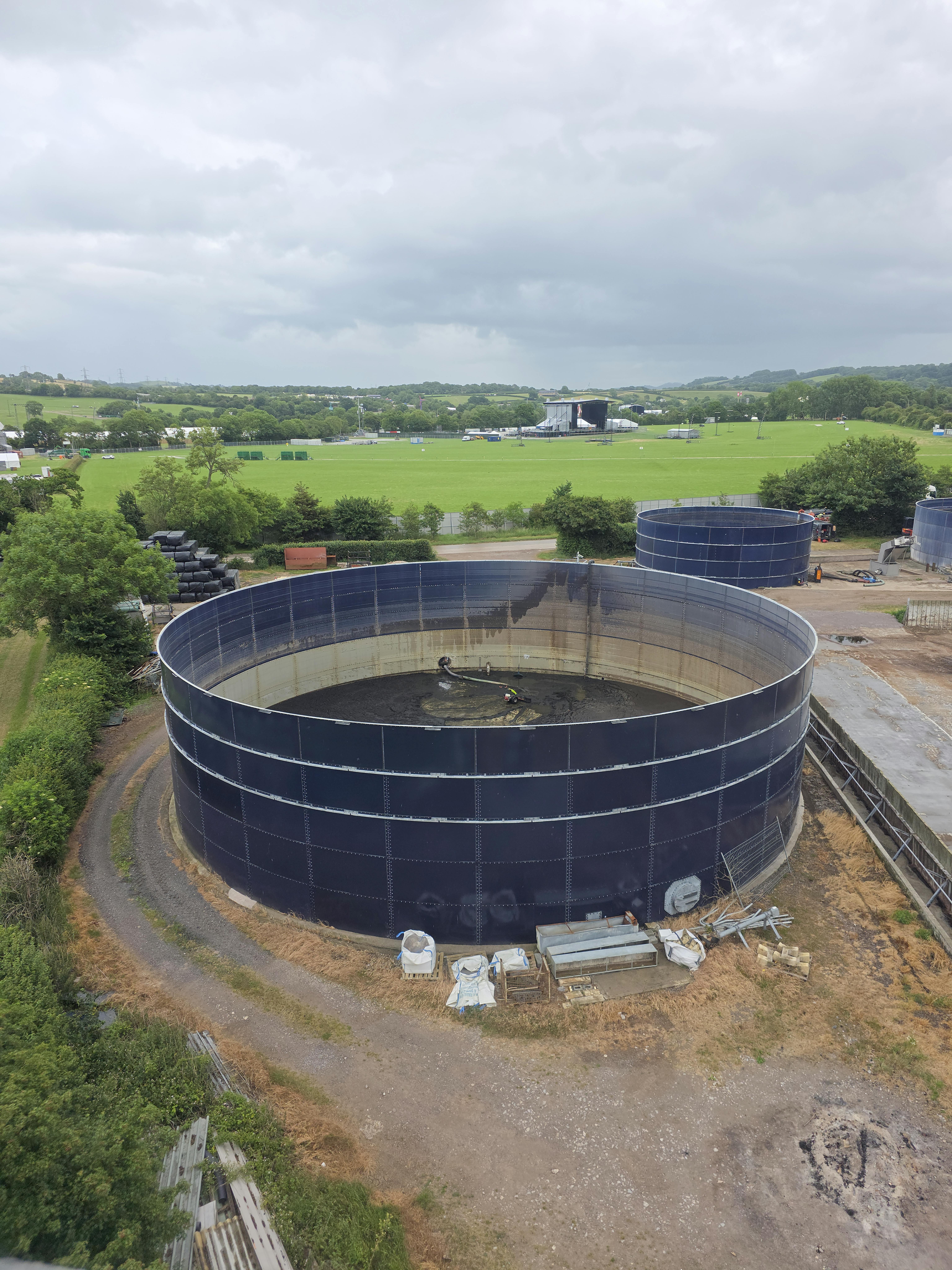 Aerial View of Large Industrial Water Tanks in Field · Free Stock Photo