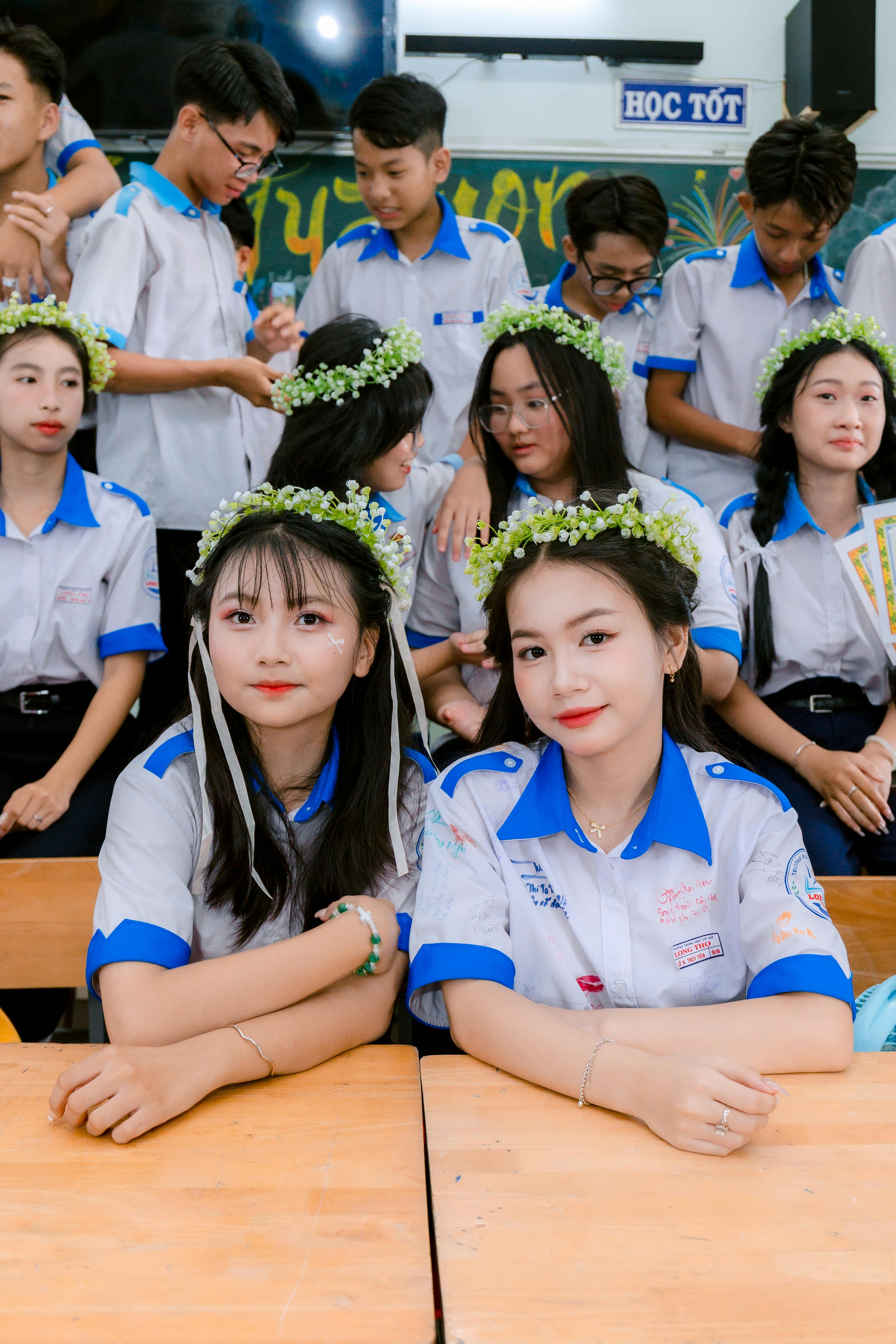 Students Celebrating Graduation with Flower Crowns · Free Stock Photo