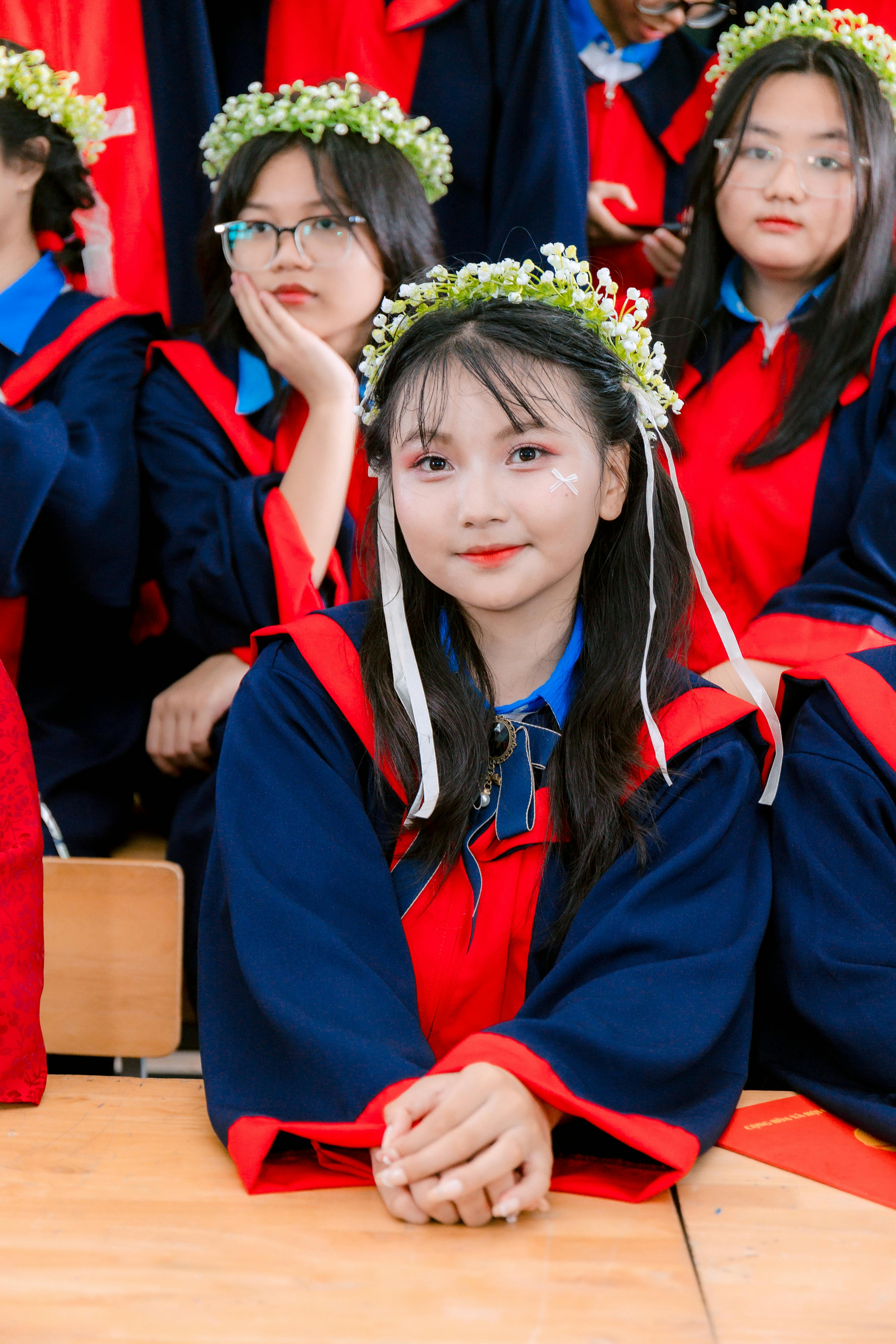 Group of Students in Graduation Attire with Floral Crowns · Free Stock ...