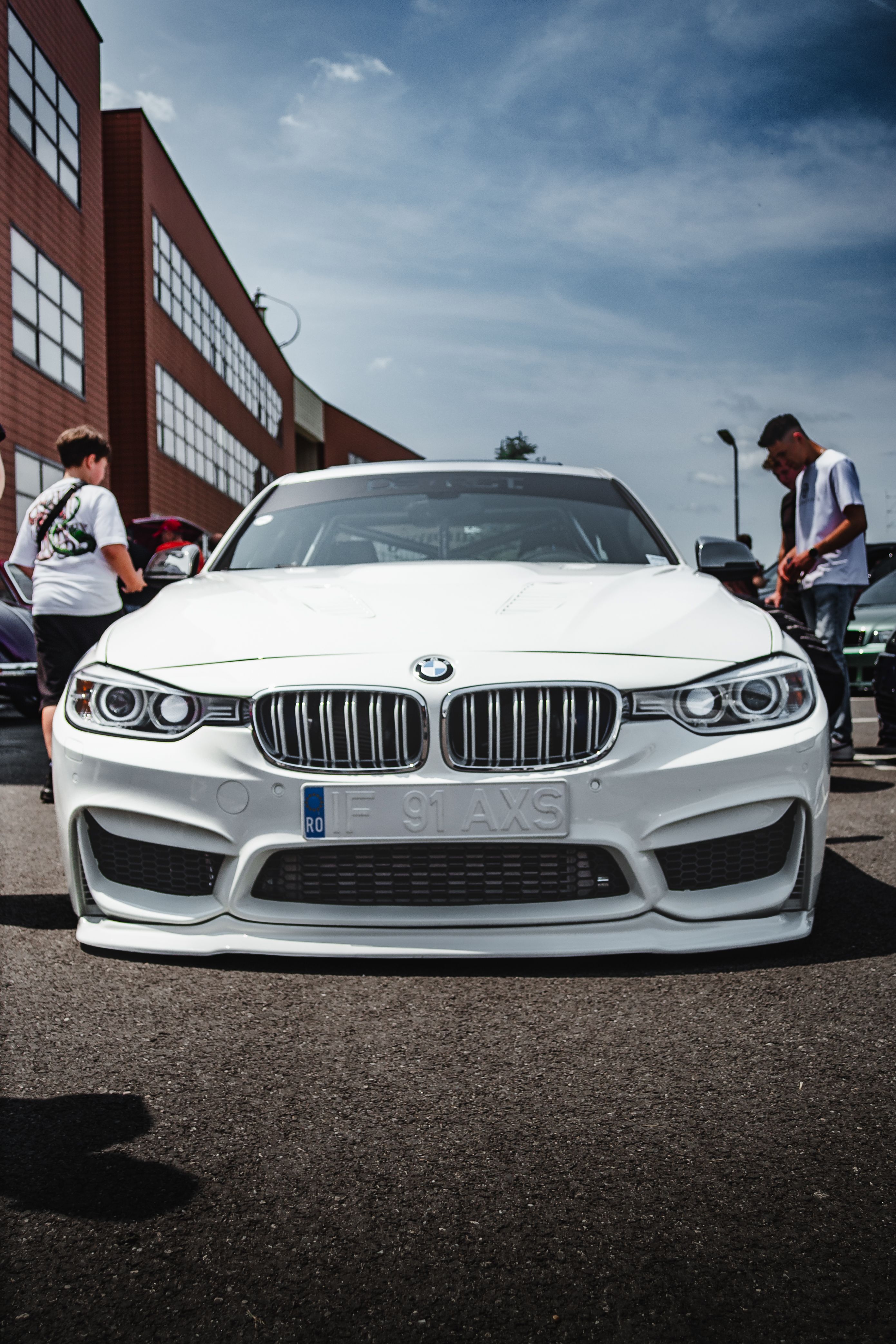 White BMW Car Front View at Outdoor Event · Free Stock Photo
