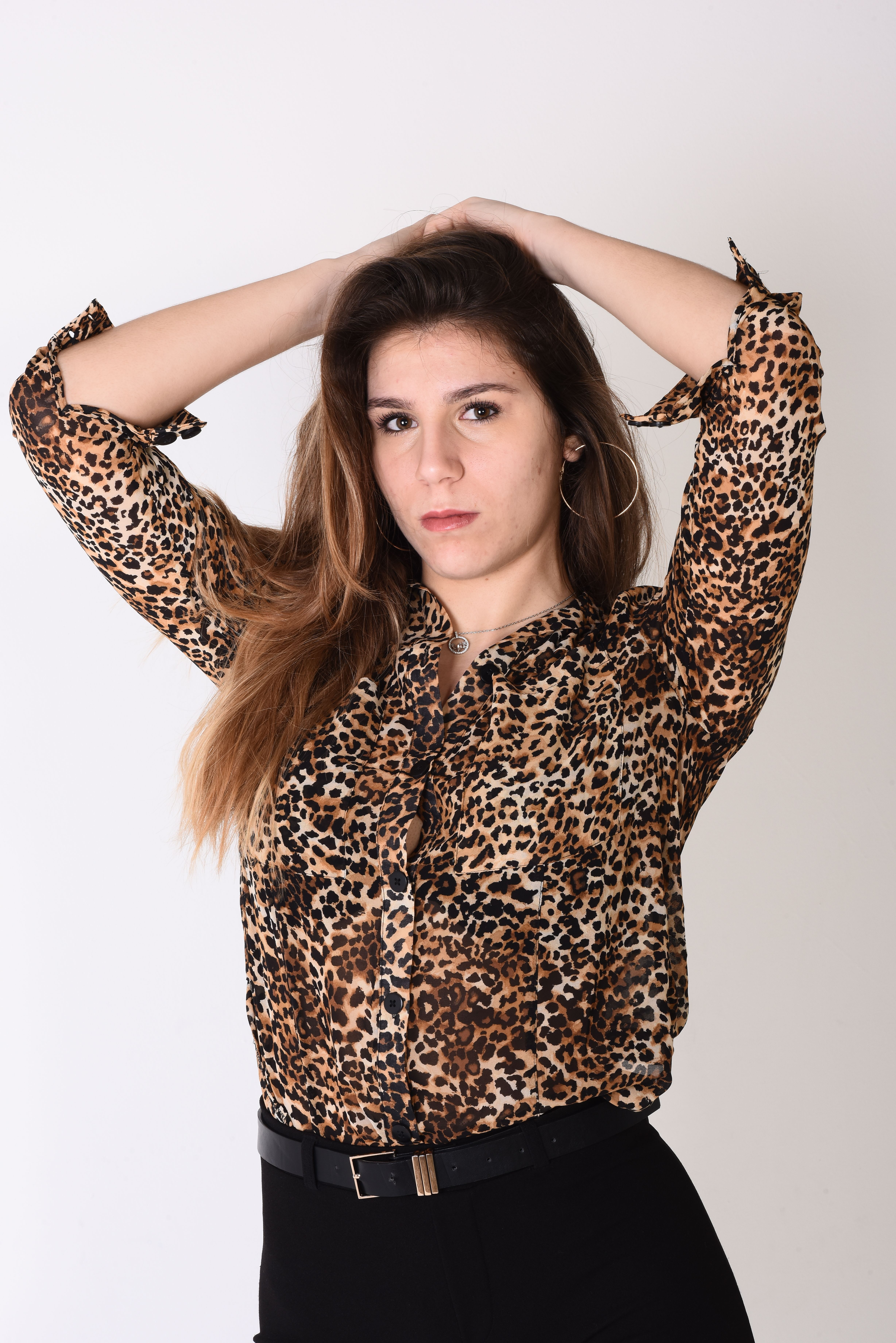 Stylish Woman in Leopard Print Top Posing Confidently · Free Stock Photo