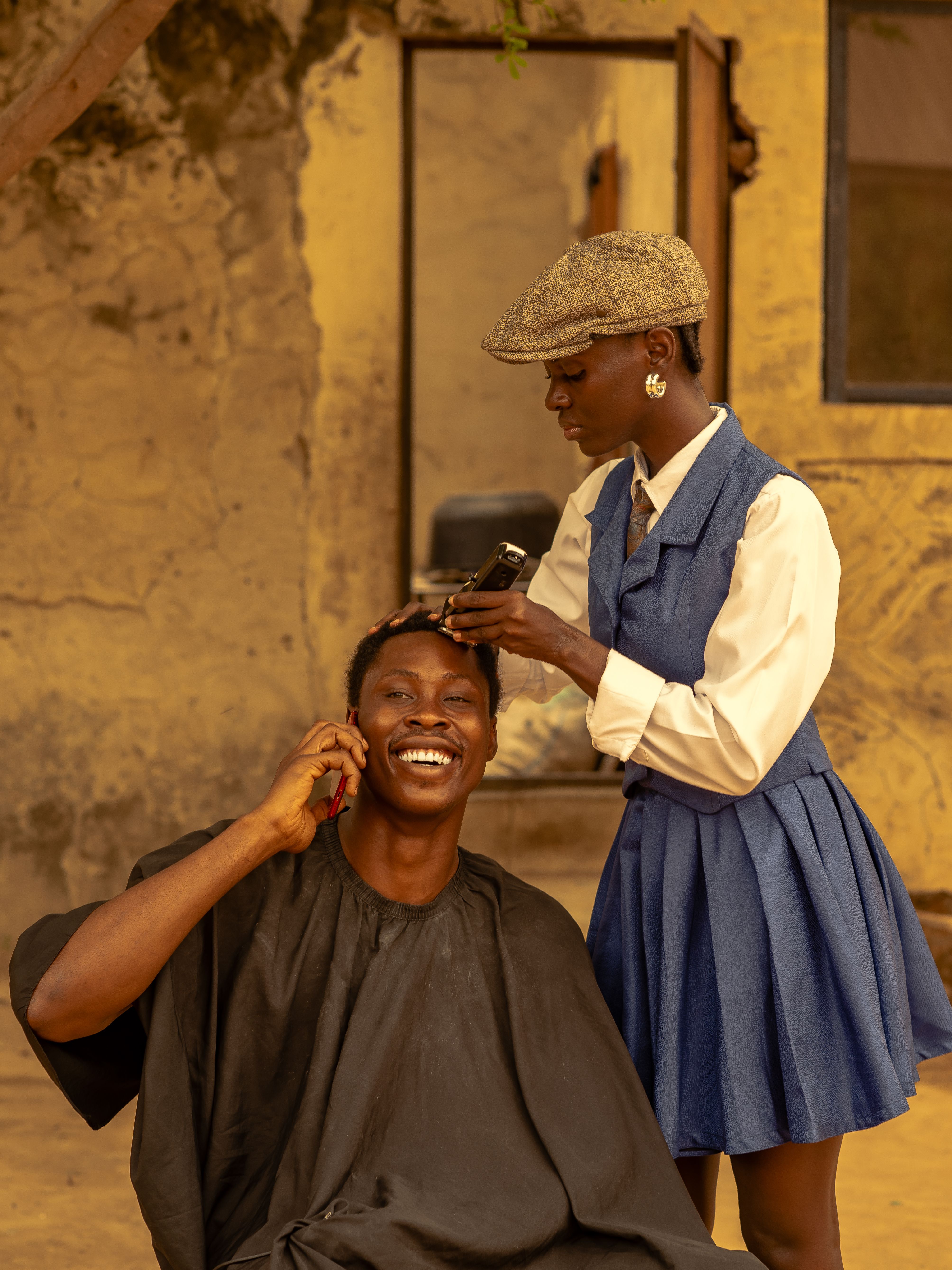 Joyful Outdoor Haircut Scene with Friends · Free Stock Photo
