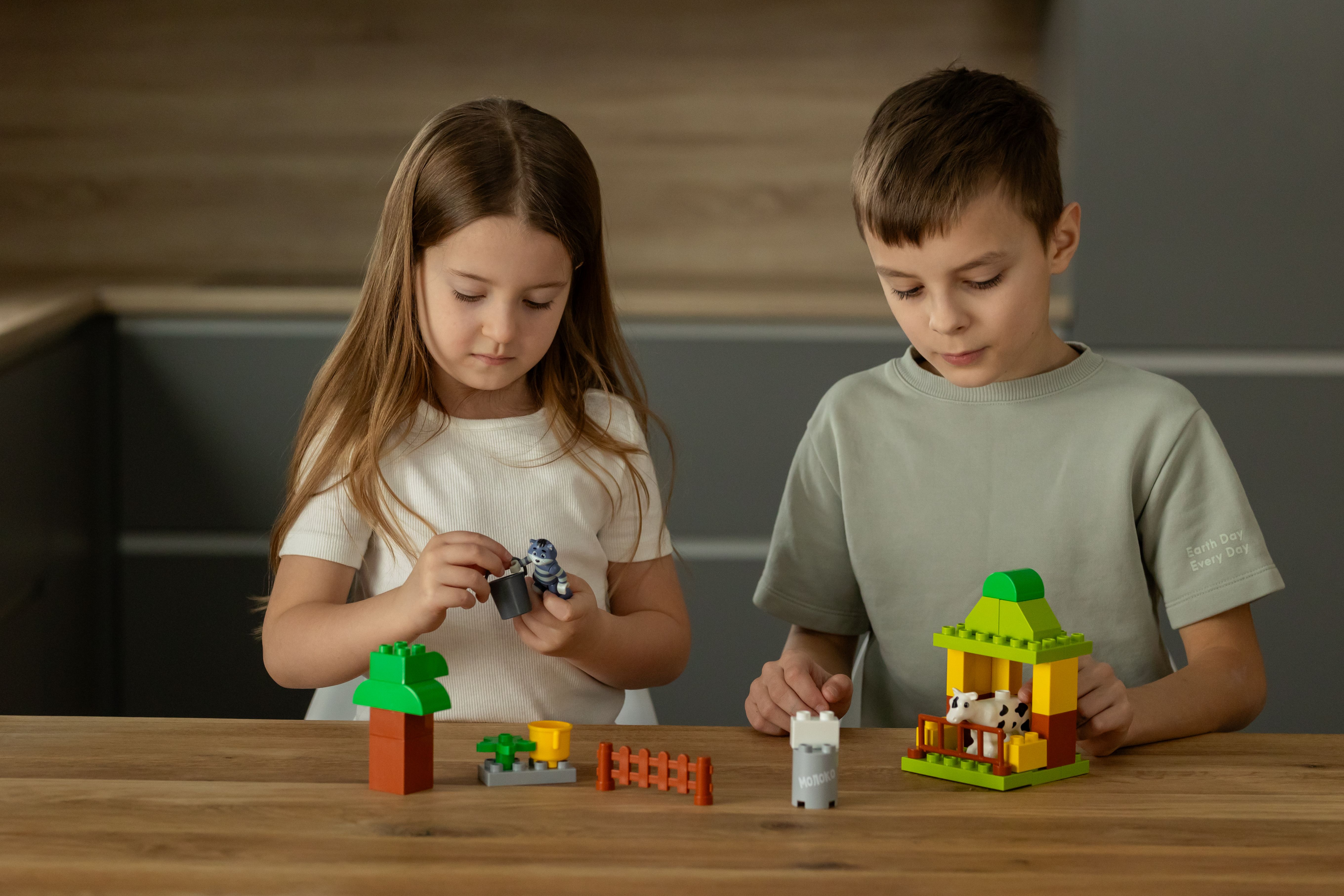 Children Engaged in Creative Play with Building Blocks · Free Stock Photo