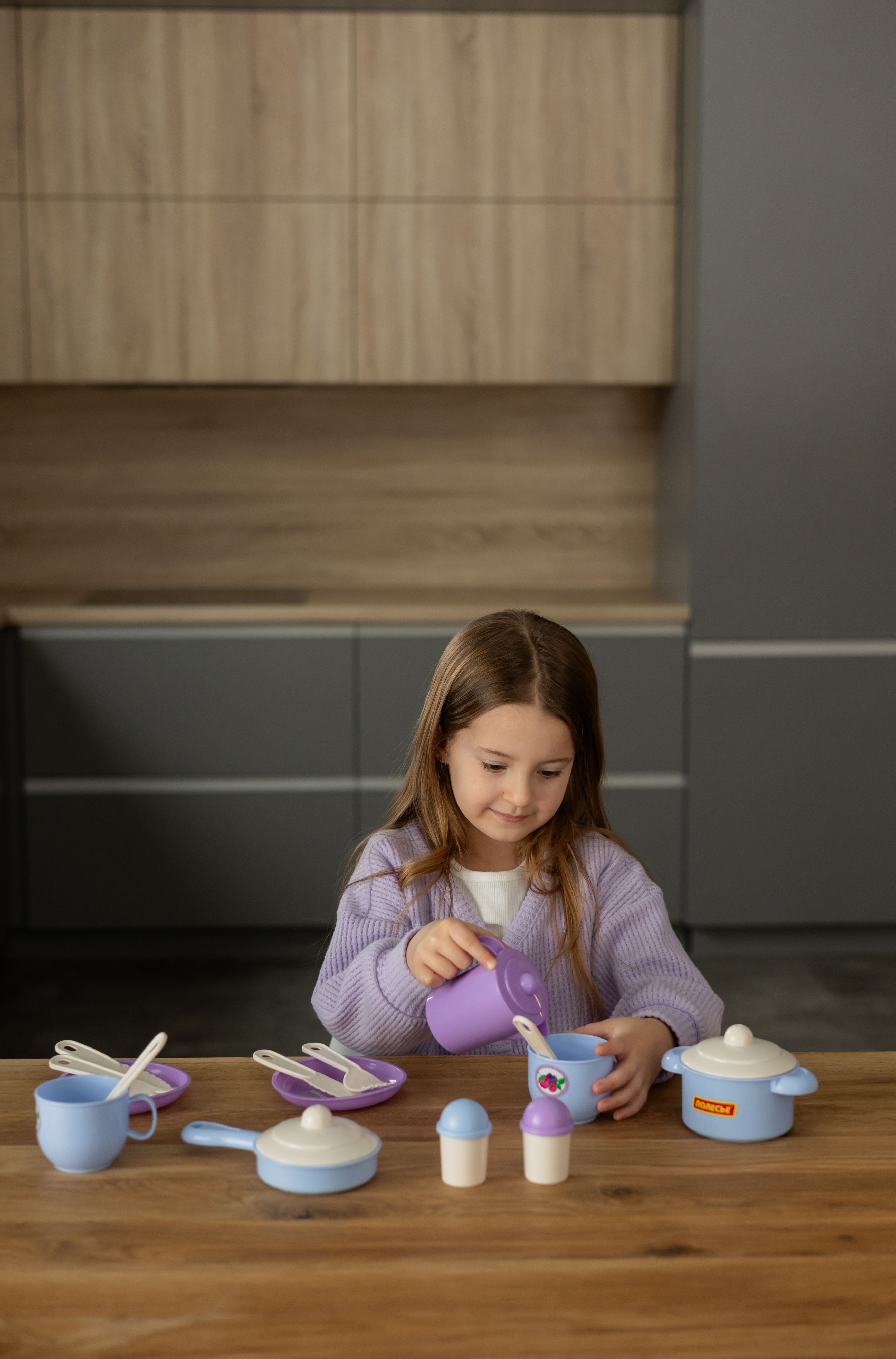 Child Playing with Toy Kitchen Set Indoors · Free Stock Photo