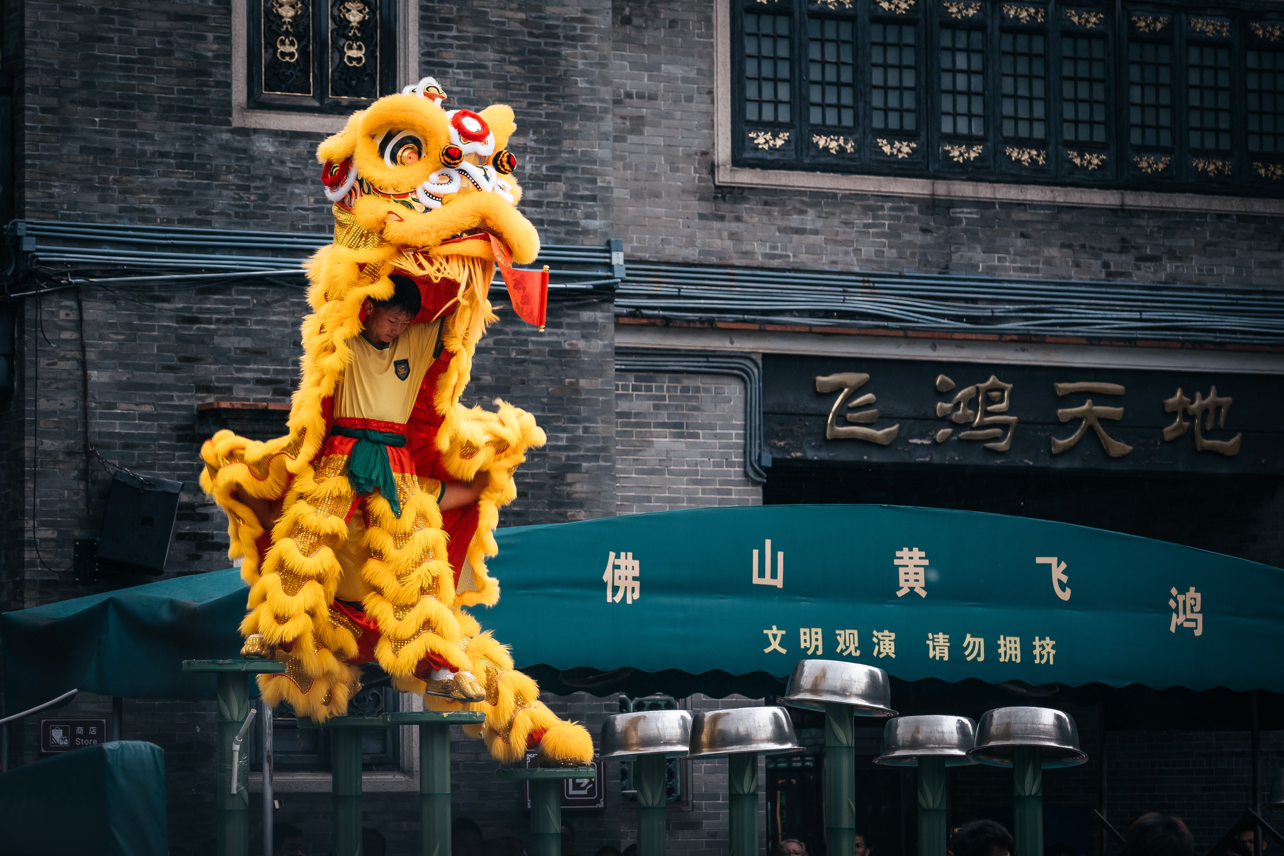 Vibrant Chinese Lion Dance Performance in City Street · Free Stock Photo