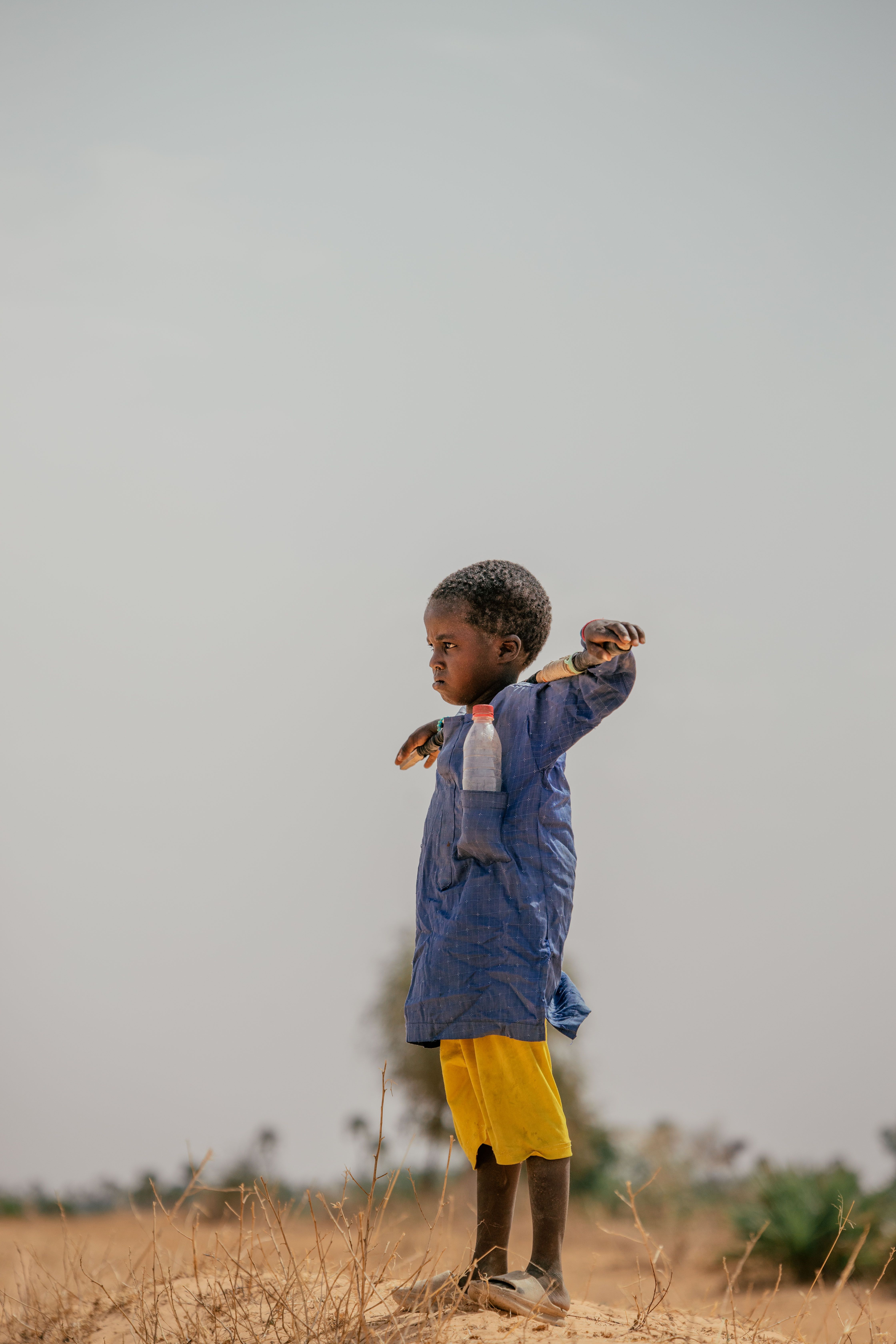 Young Child Standing Outdoors in Casual Clothes · Free Stock Photo