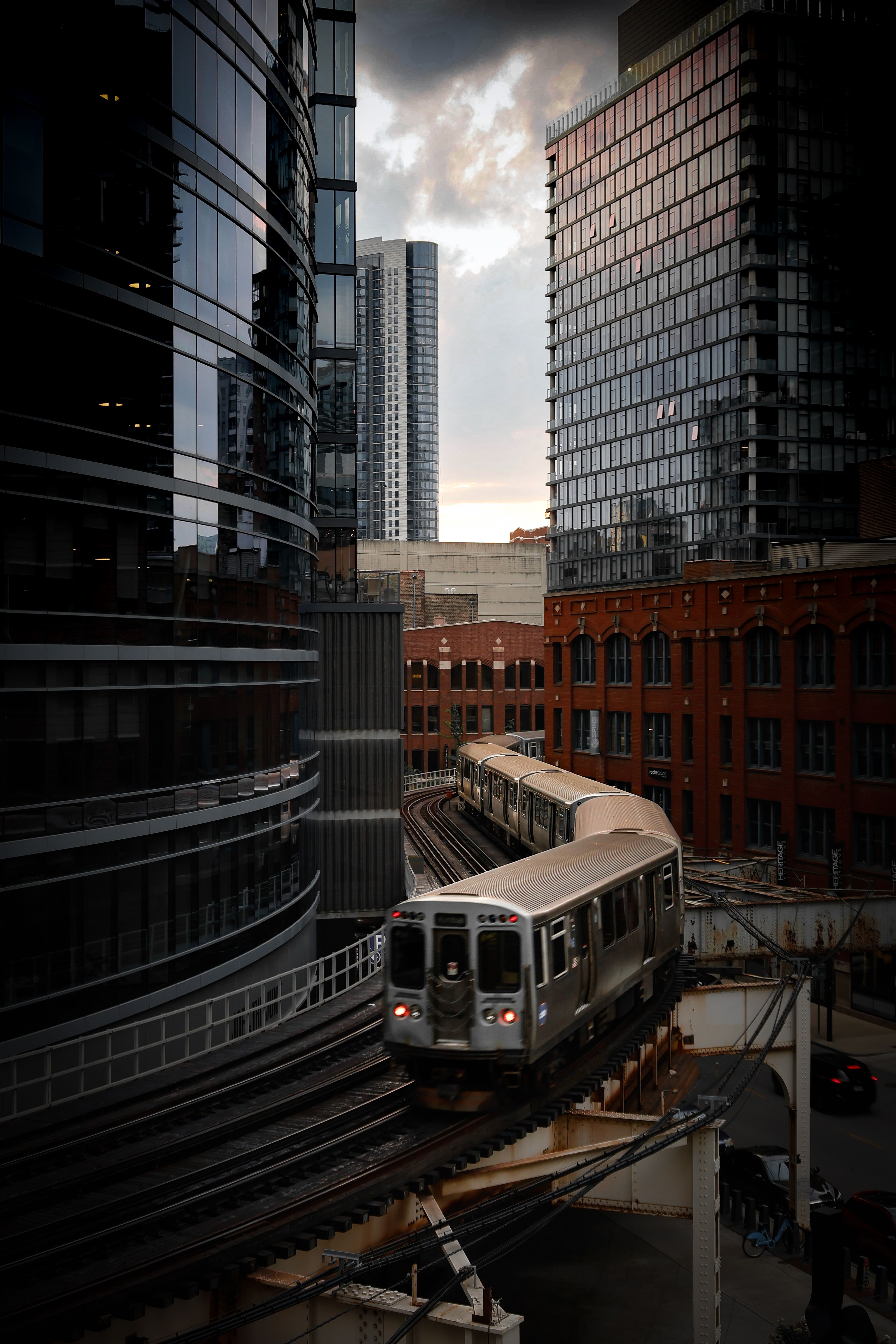 Modern Urban Train Passing Through Cityscape · Free Stock Photo
