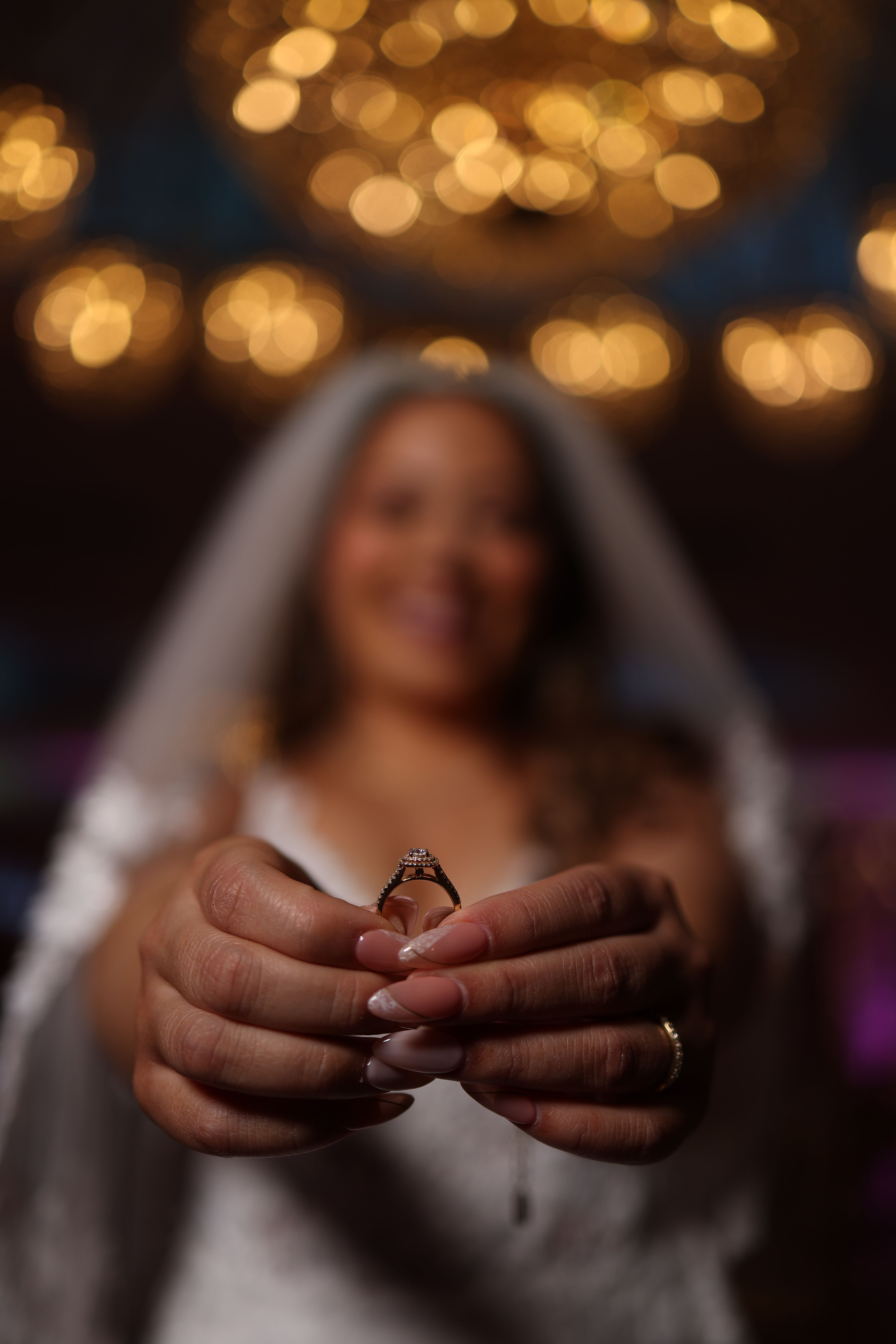 Bride Holding Engagement Ring with Bokeh Background · Free Stock Photo