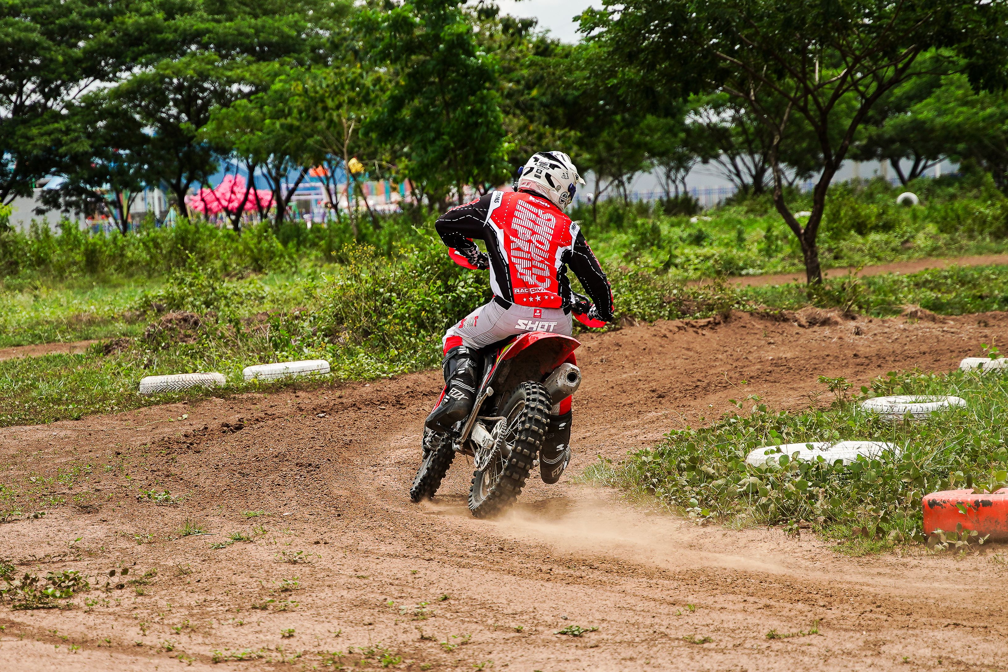 Motocross Racer Biking on Dirt Track Outdoors · Free Stock Photo