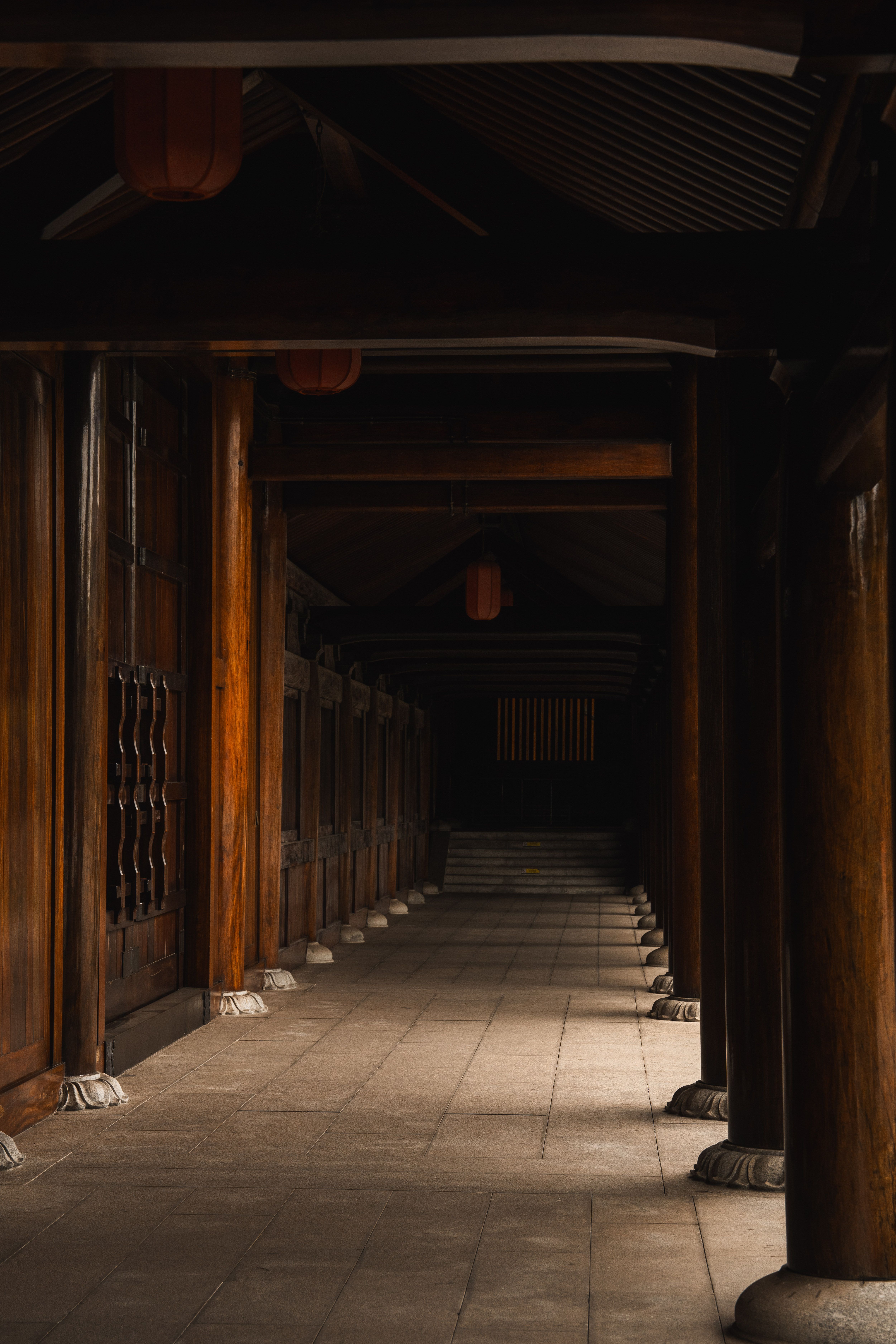 Dimly Lit Wooden Corridor in Traditional Architecture · Free Stock Photo