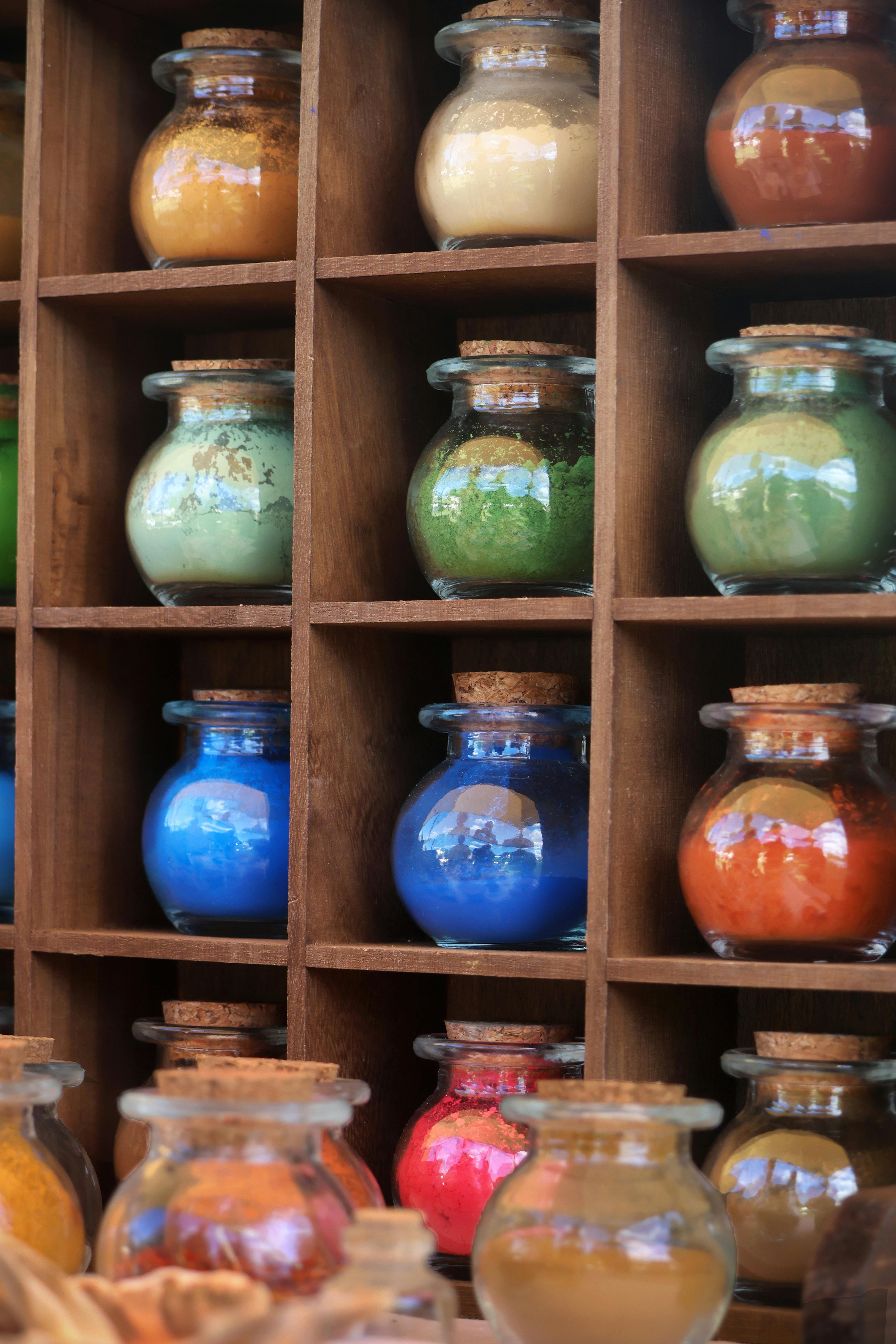 Colorful Pigment Jars in Wooden Shelf Display · Free Stock Photo