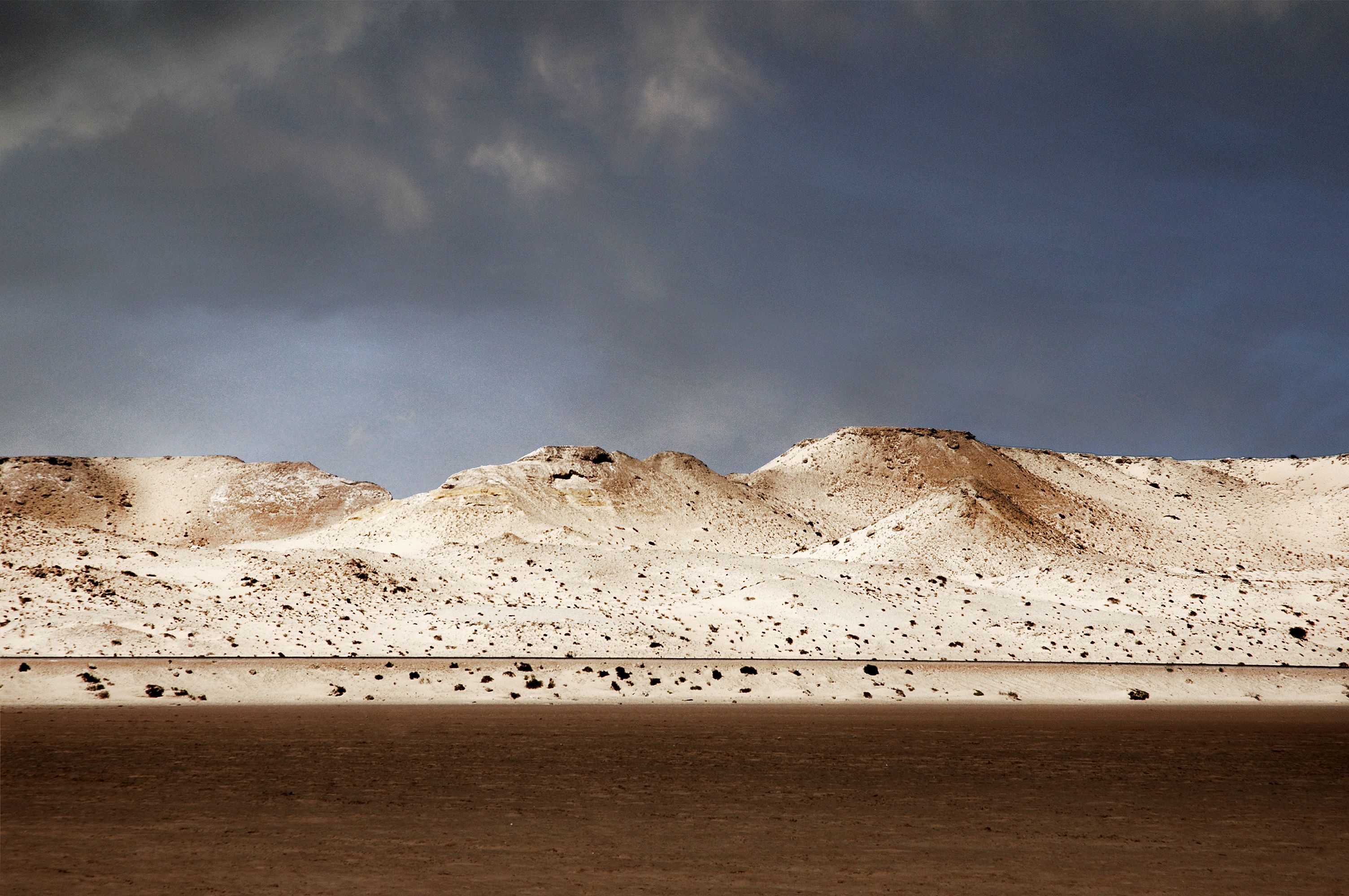 Dramatic Desert Landscape Under Moody Skies · Free Stock Photo