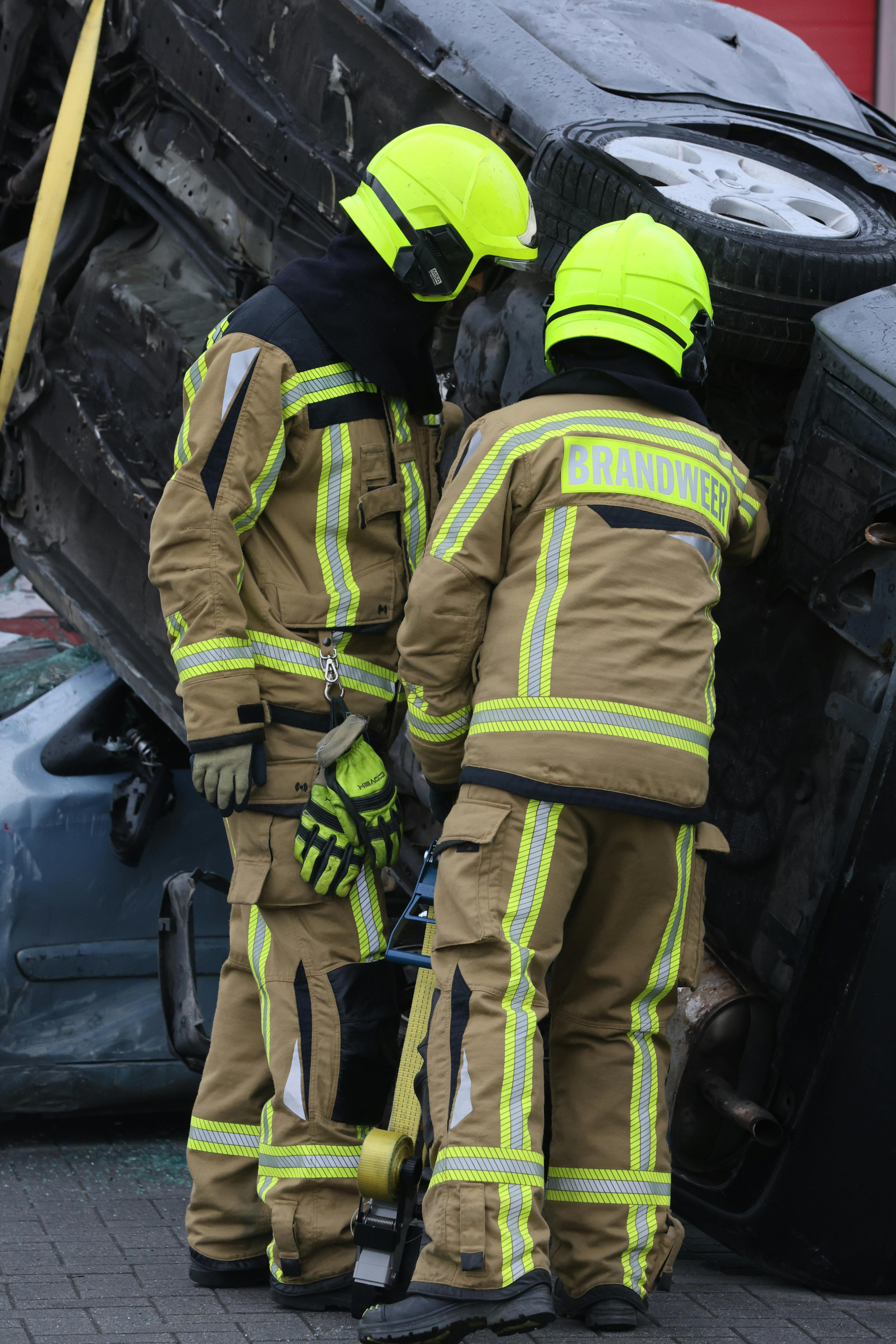 Firefighters Assessing Car Accident Scene · Free Stock Photo