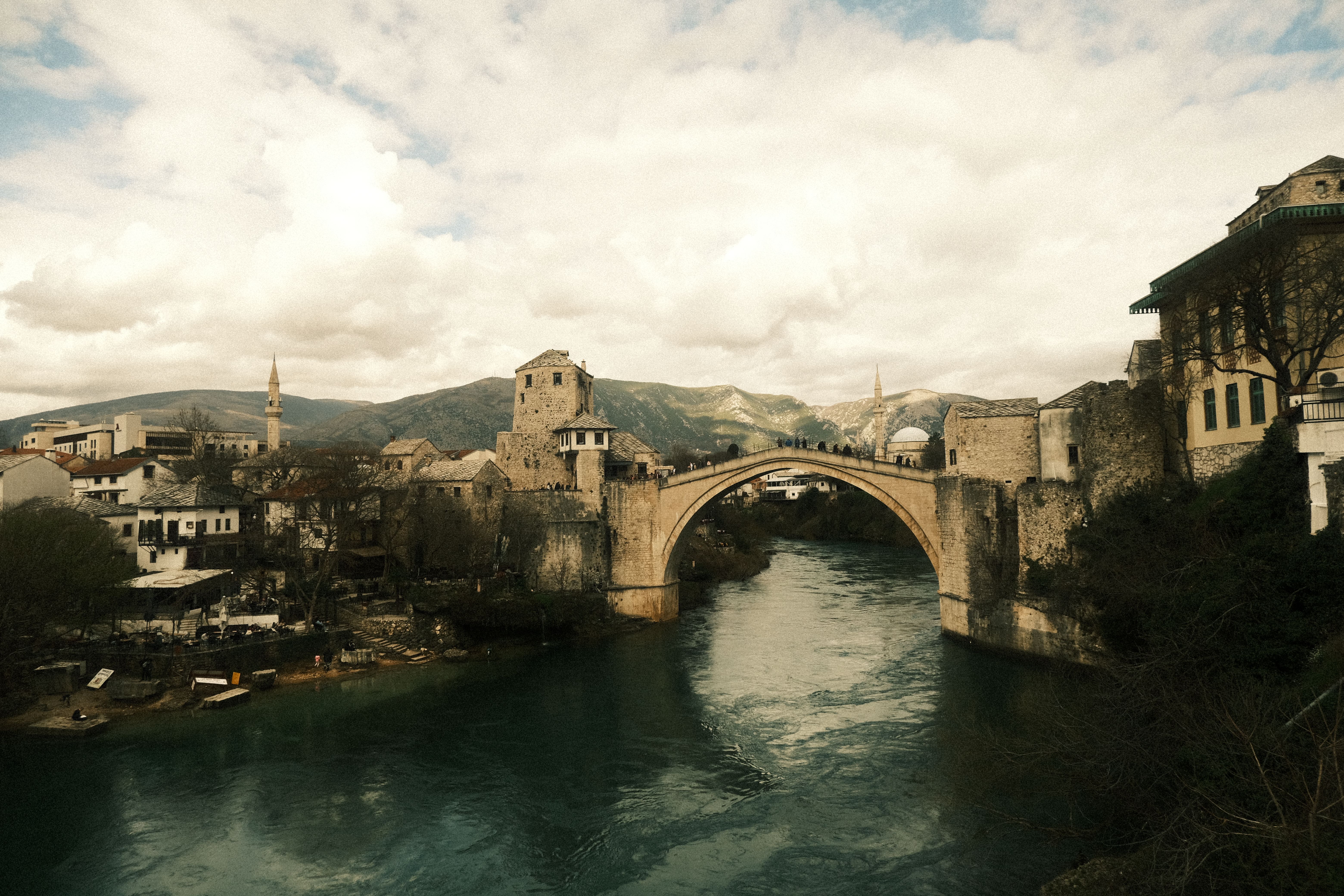 Historic Old Bridge of Mostar Beneath Cloudy Skies · Free Stock Photo