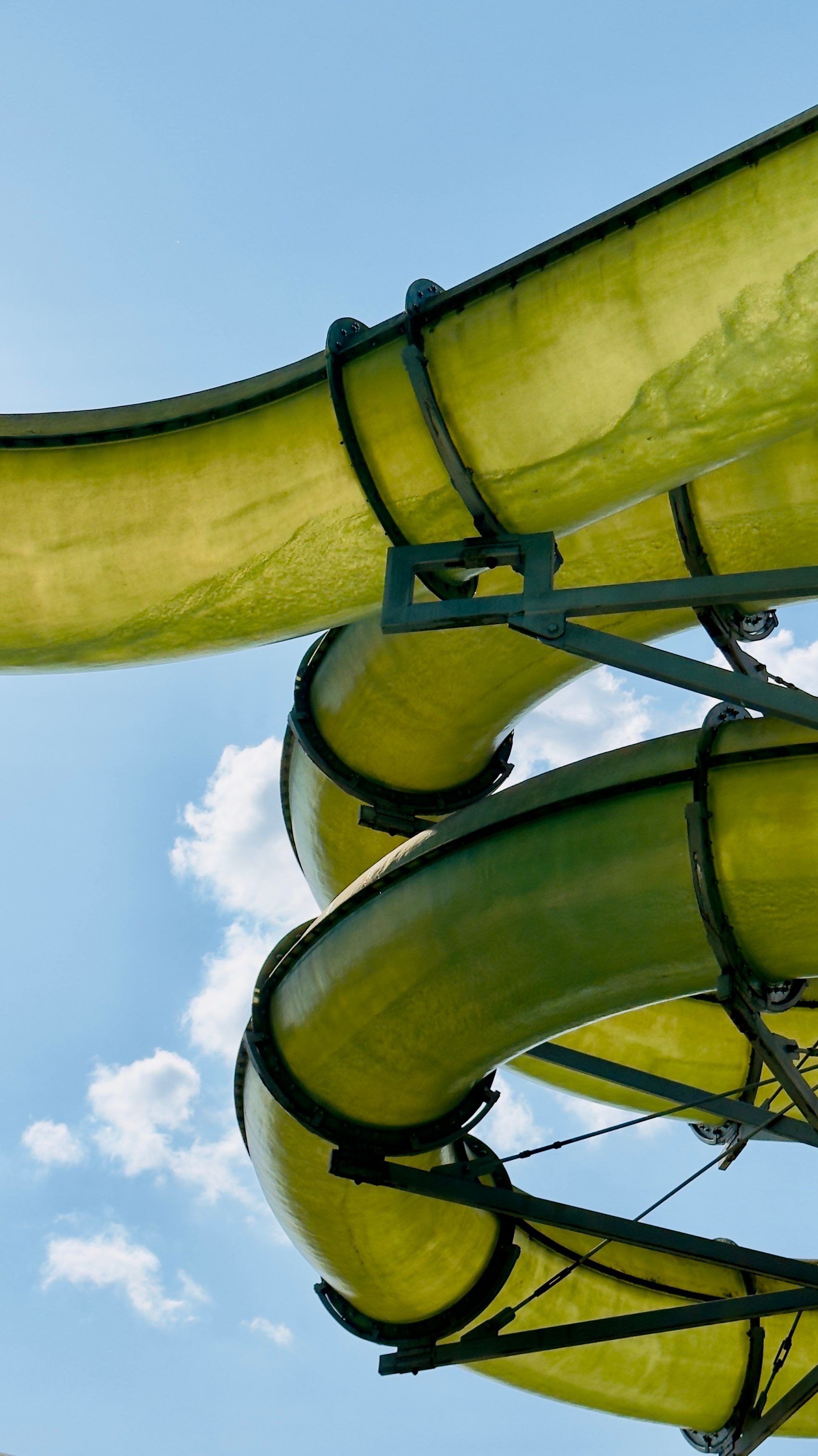 Close-Up of Twist Water Slide Against Blue Sky · Free Stock Photo