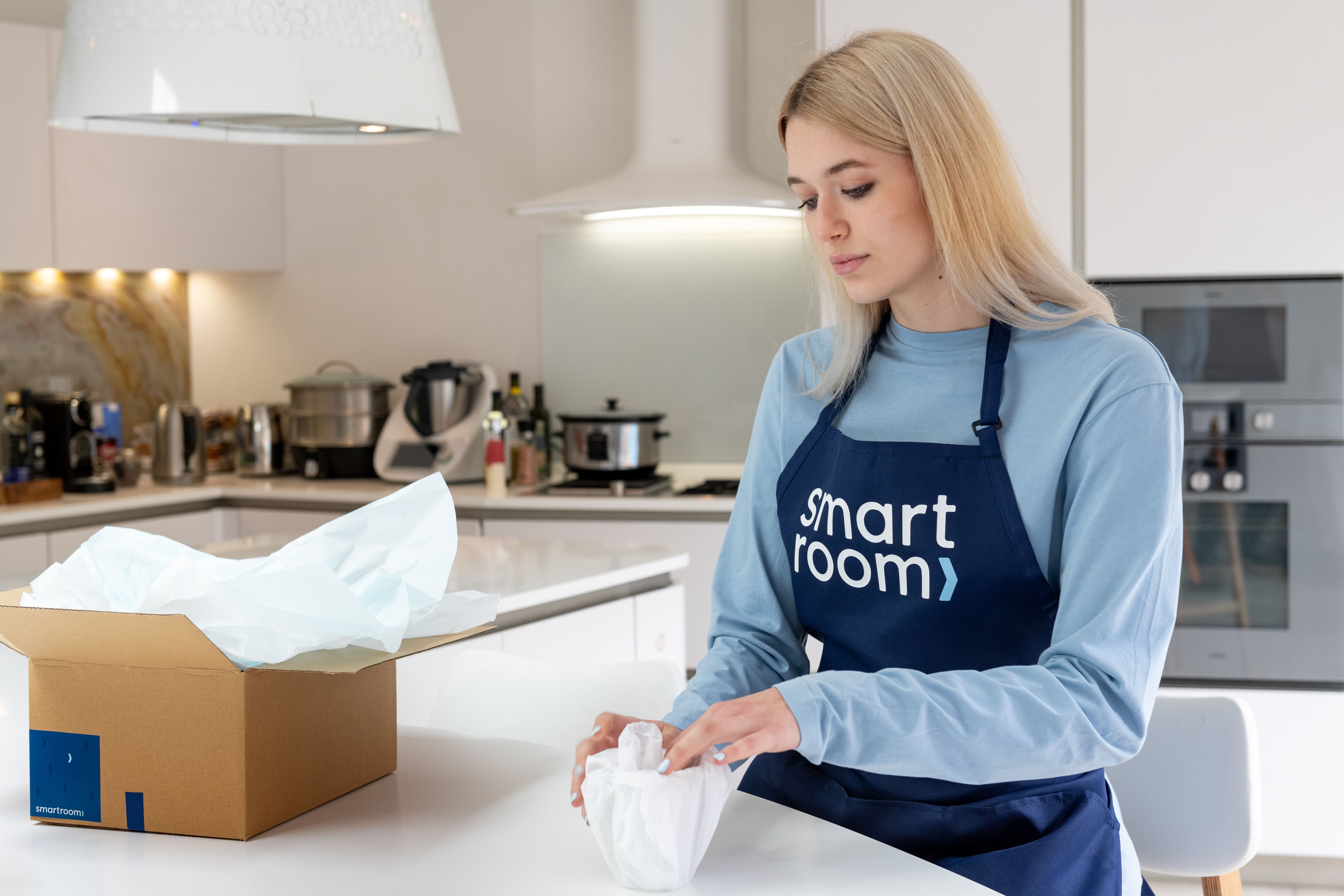 Young Woman Unpacking Box in Modern Kitchen · Free Stock Photo