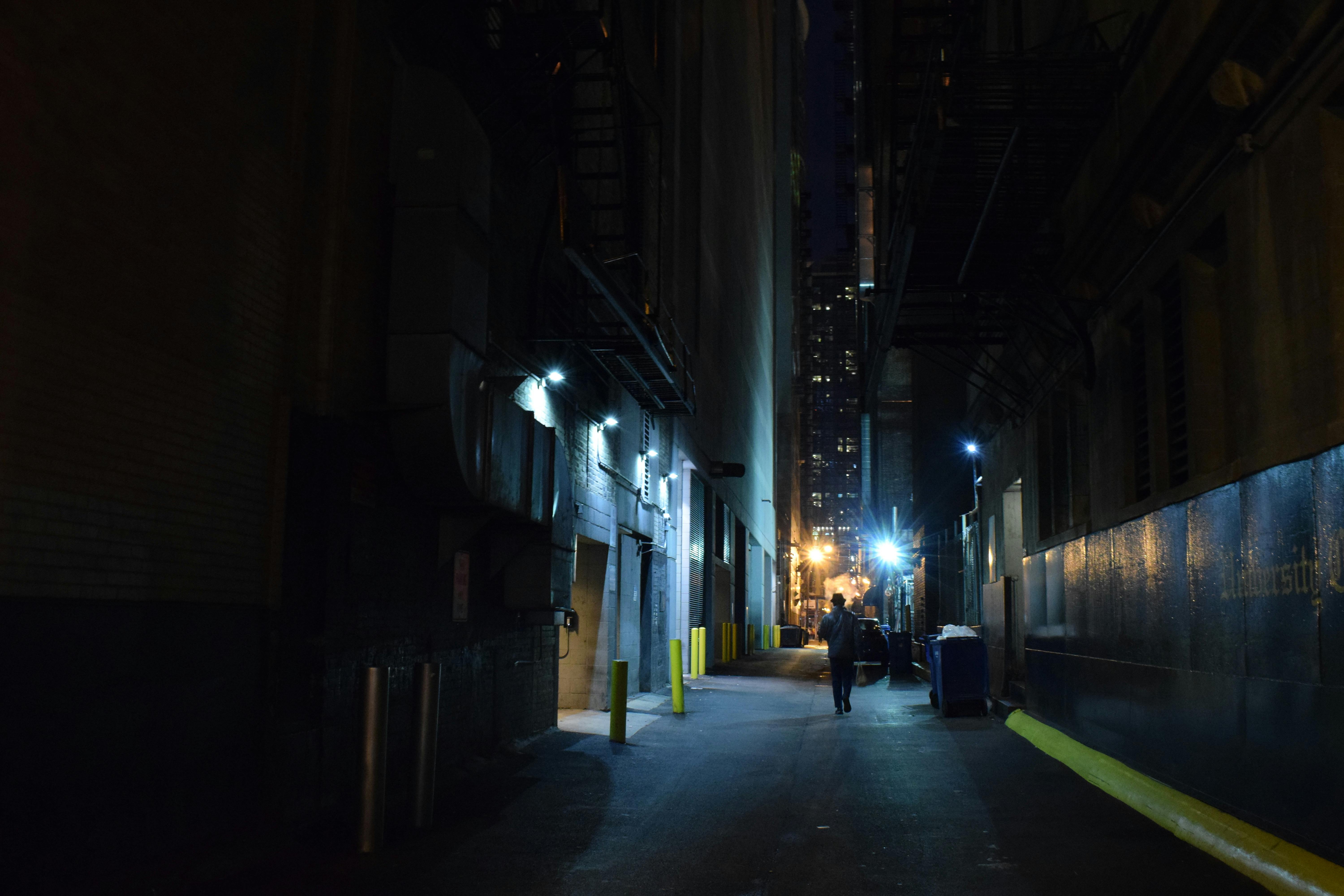 Person Walking in Between of Buildings · Free Stock Photo
