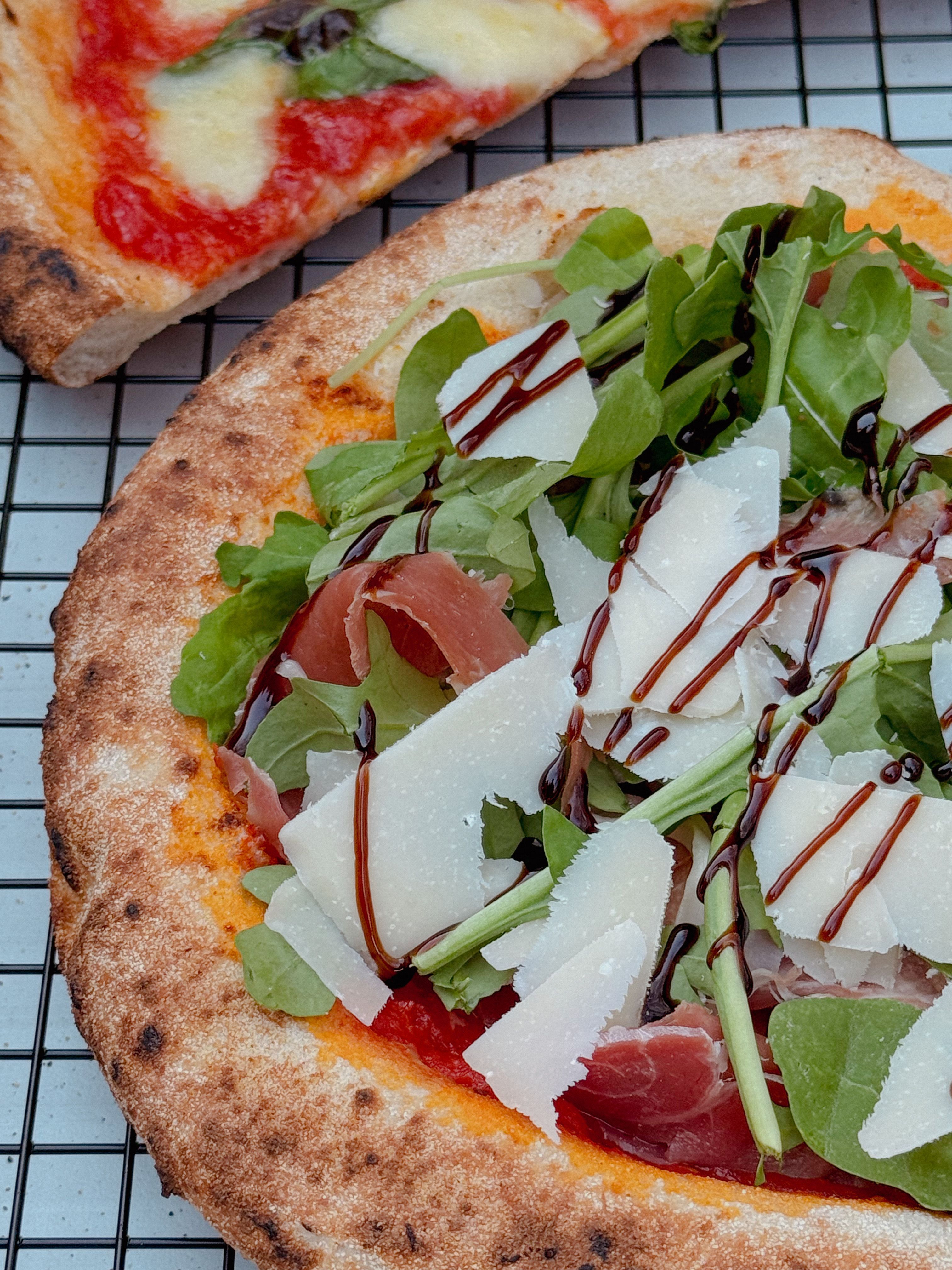 Delicious Italian Pizza with Rocket and Prosciutto · Free Stock Photo