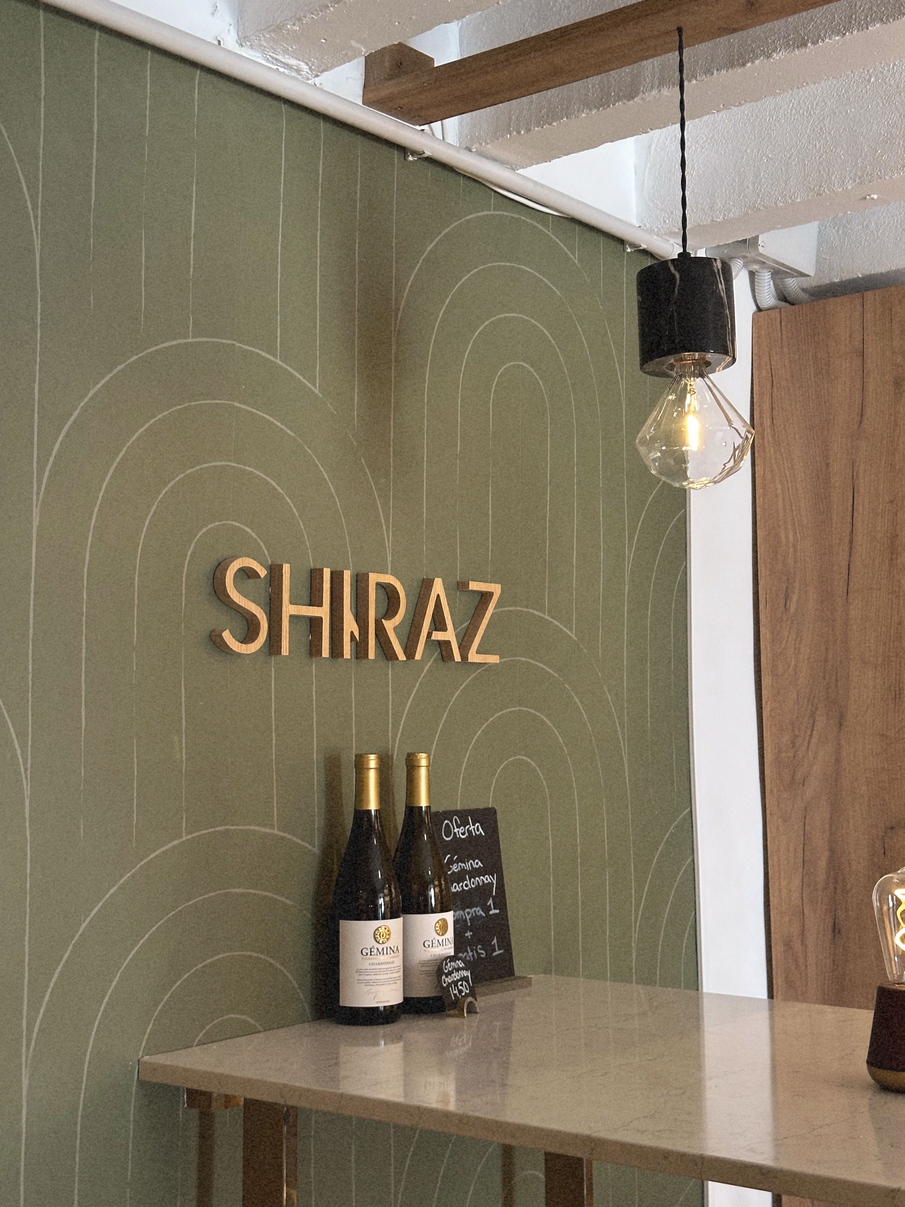 Modern Wine Bar Interior with Shiraz Sign · Free Stock Photo