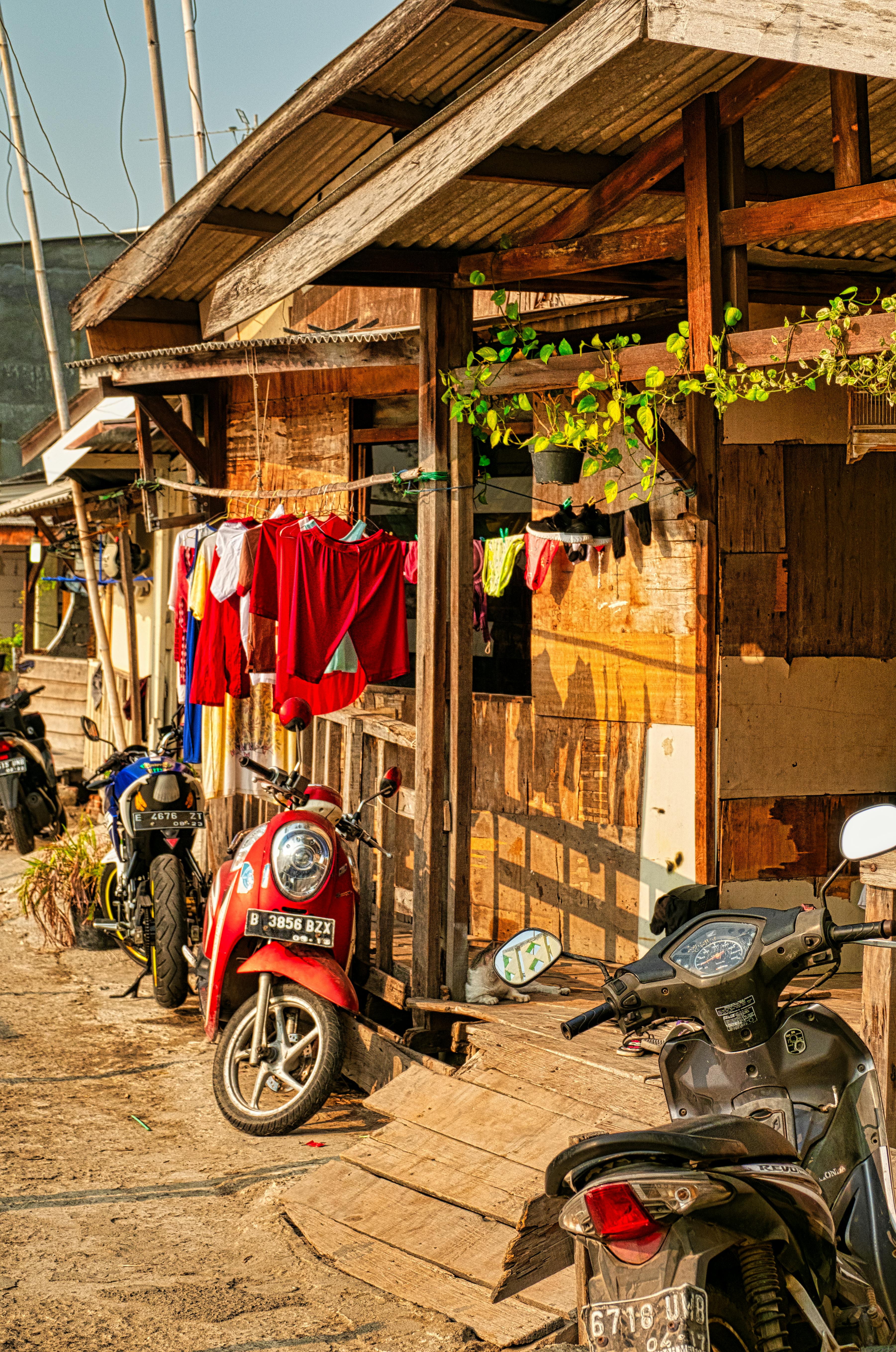 Motorcycle Parked on Brown House · Free Stock Photo
