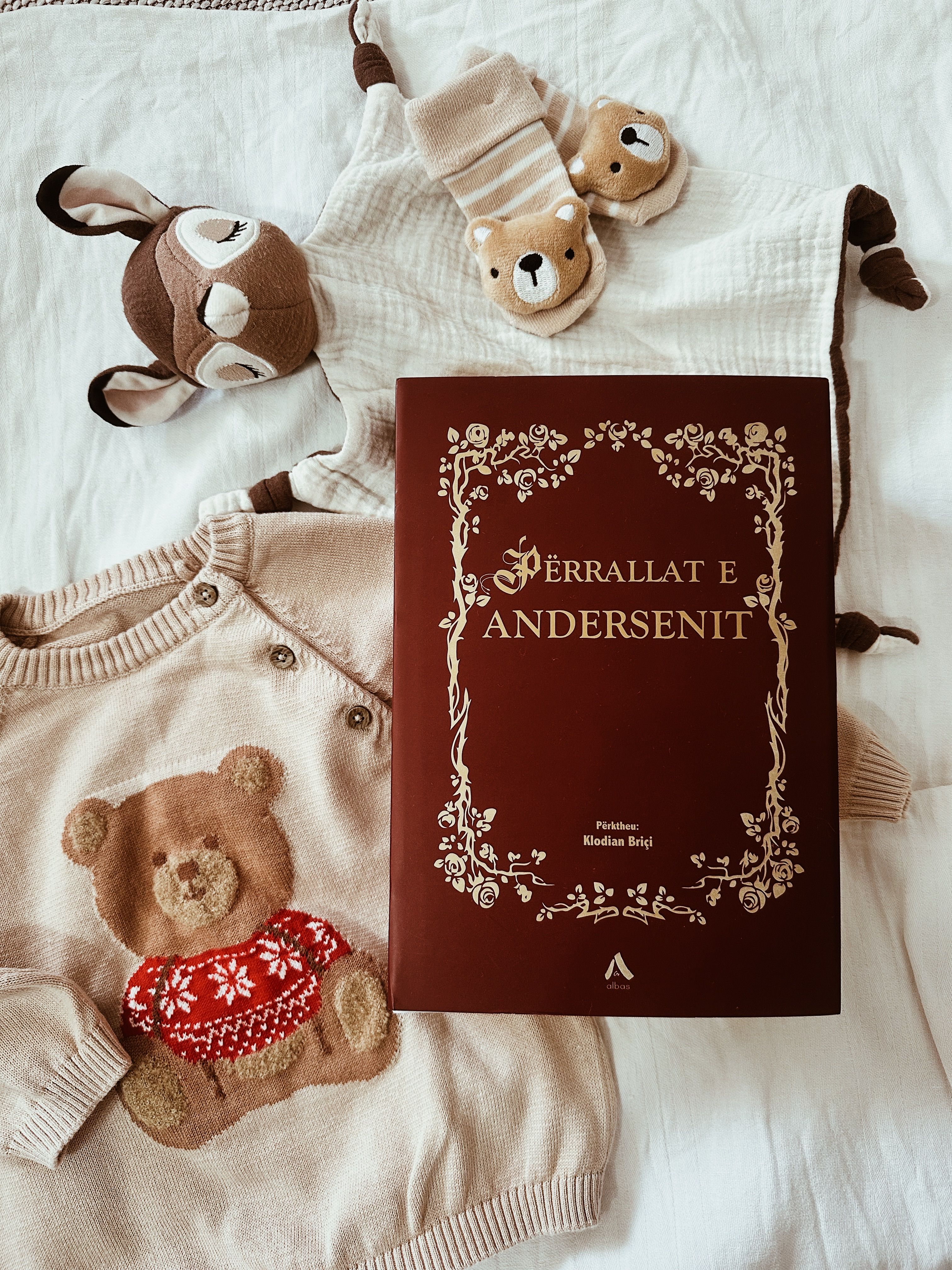 Cozy Baby Clothes and Storybook Arrangement · Free Stock Photo