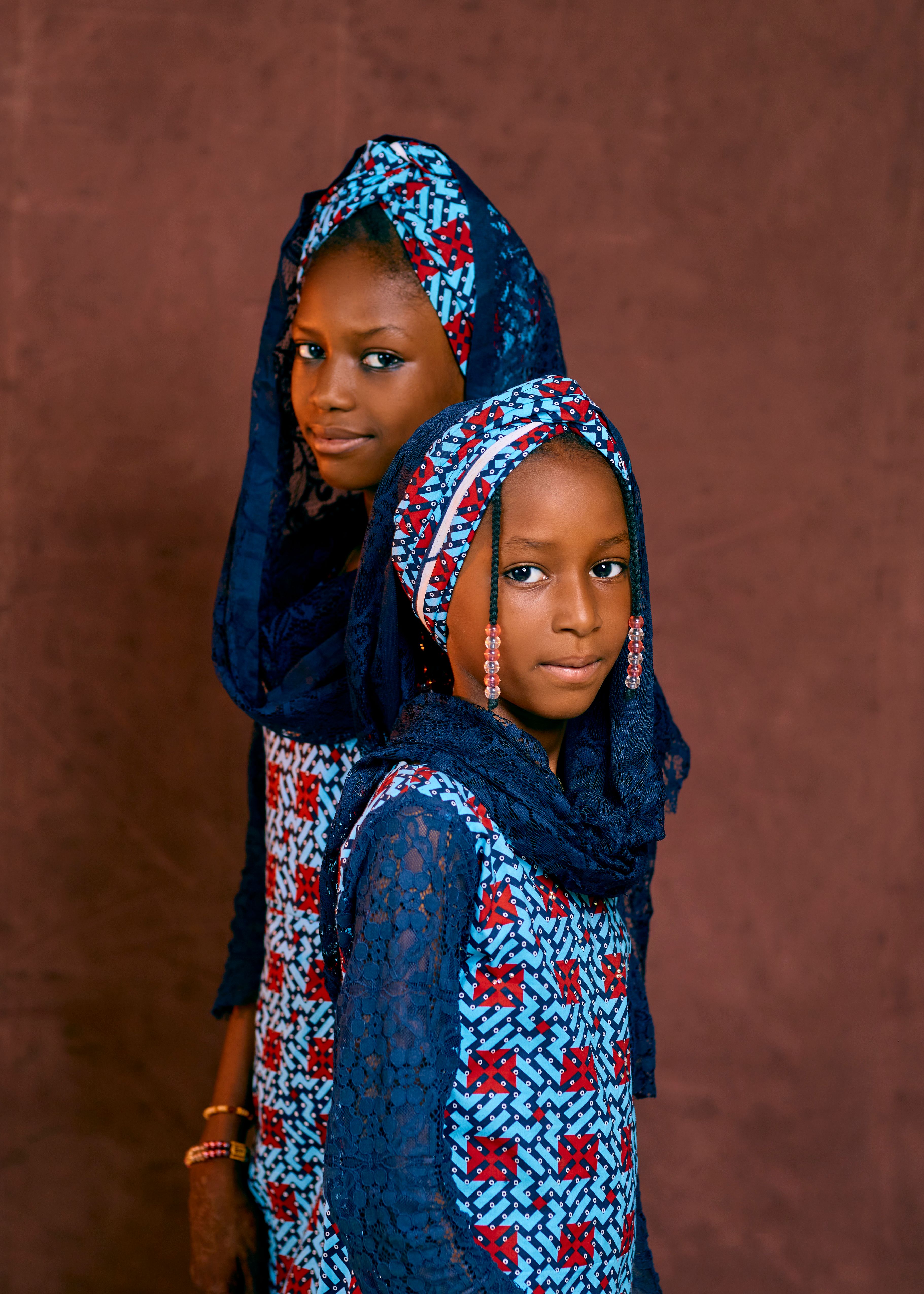 Portrait of Two Young Girls in Traditional Attire · Free Stock Photo