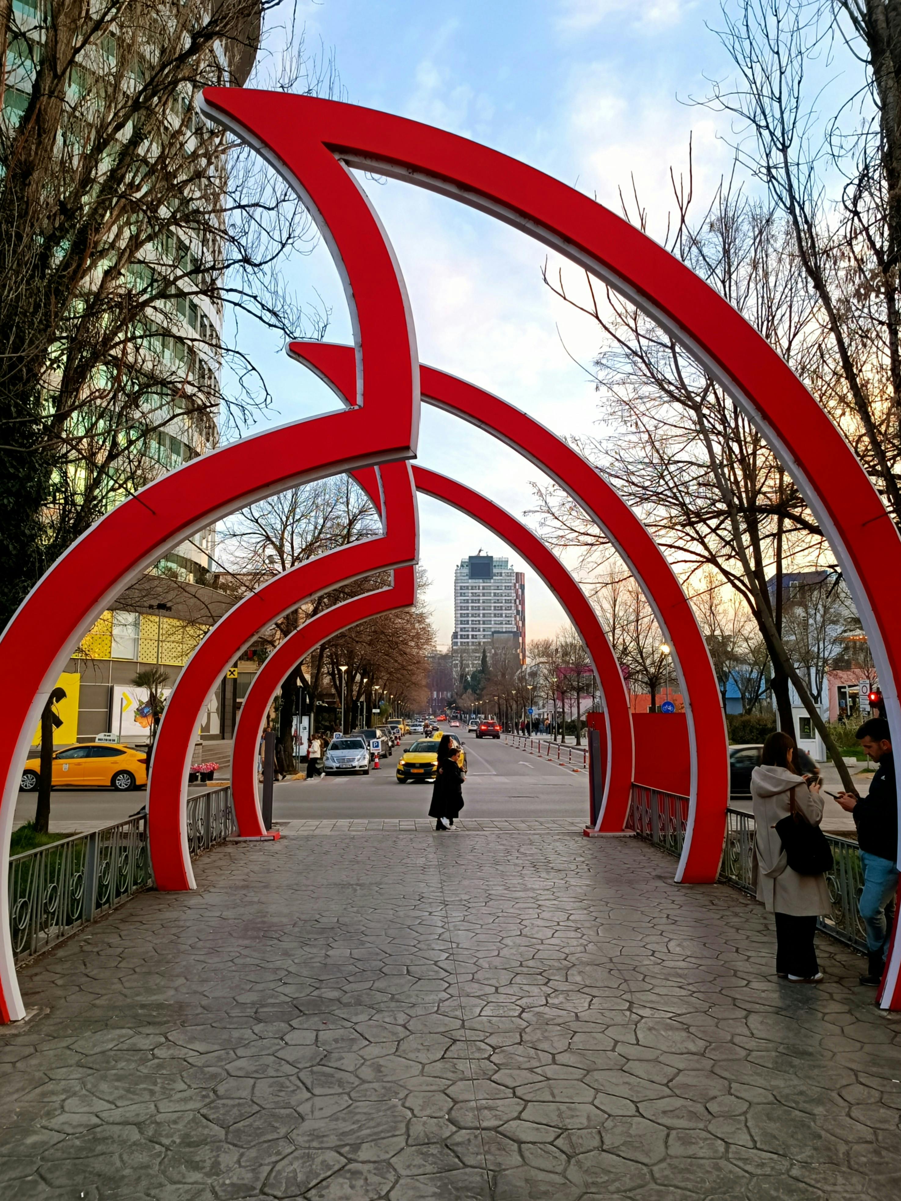 Modern Red Archway in Vibrant Street Setting · Free Stock Photo