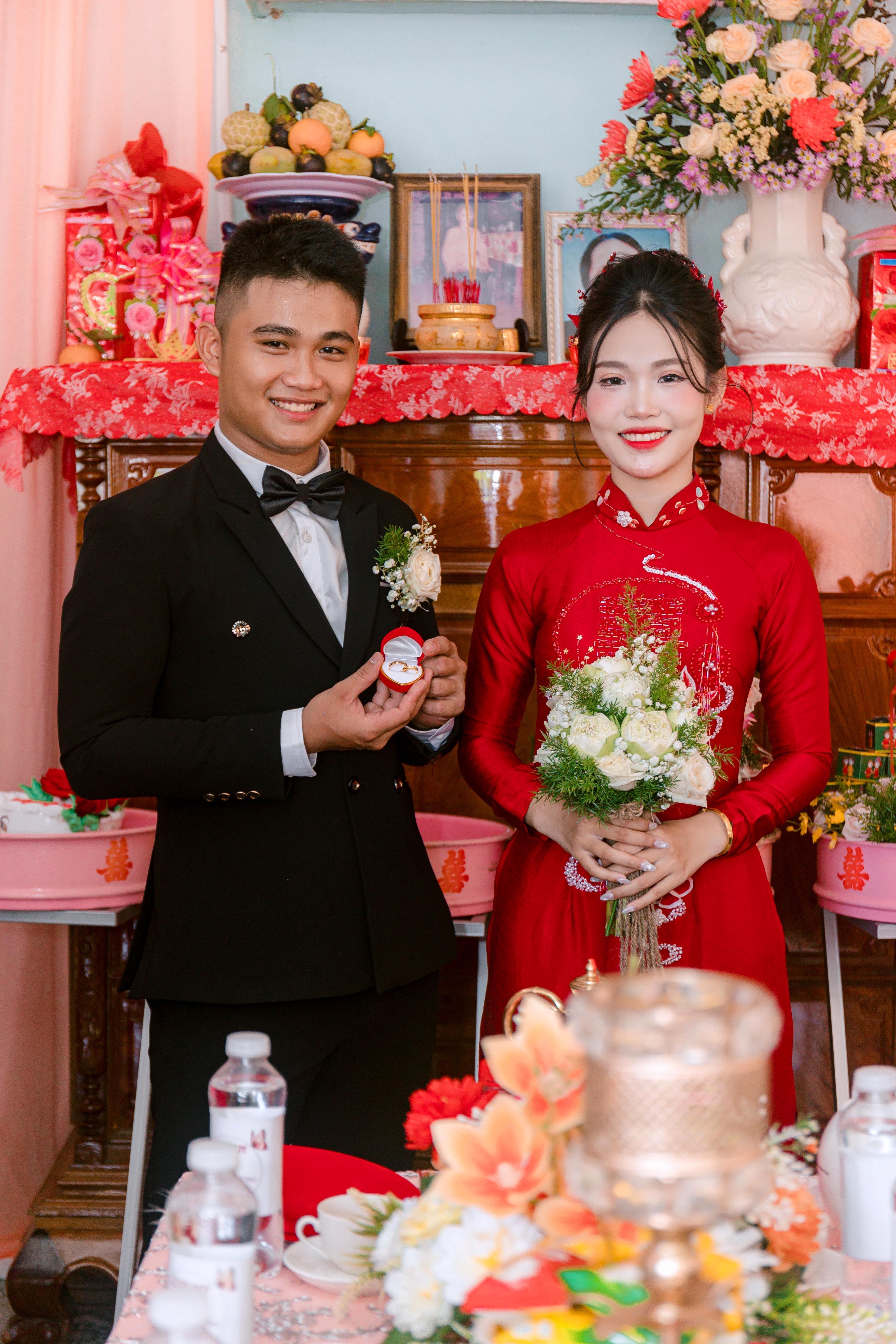 Traditional Wedding Couple in Vibrant Attire · Free Stock Photo