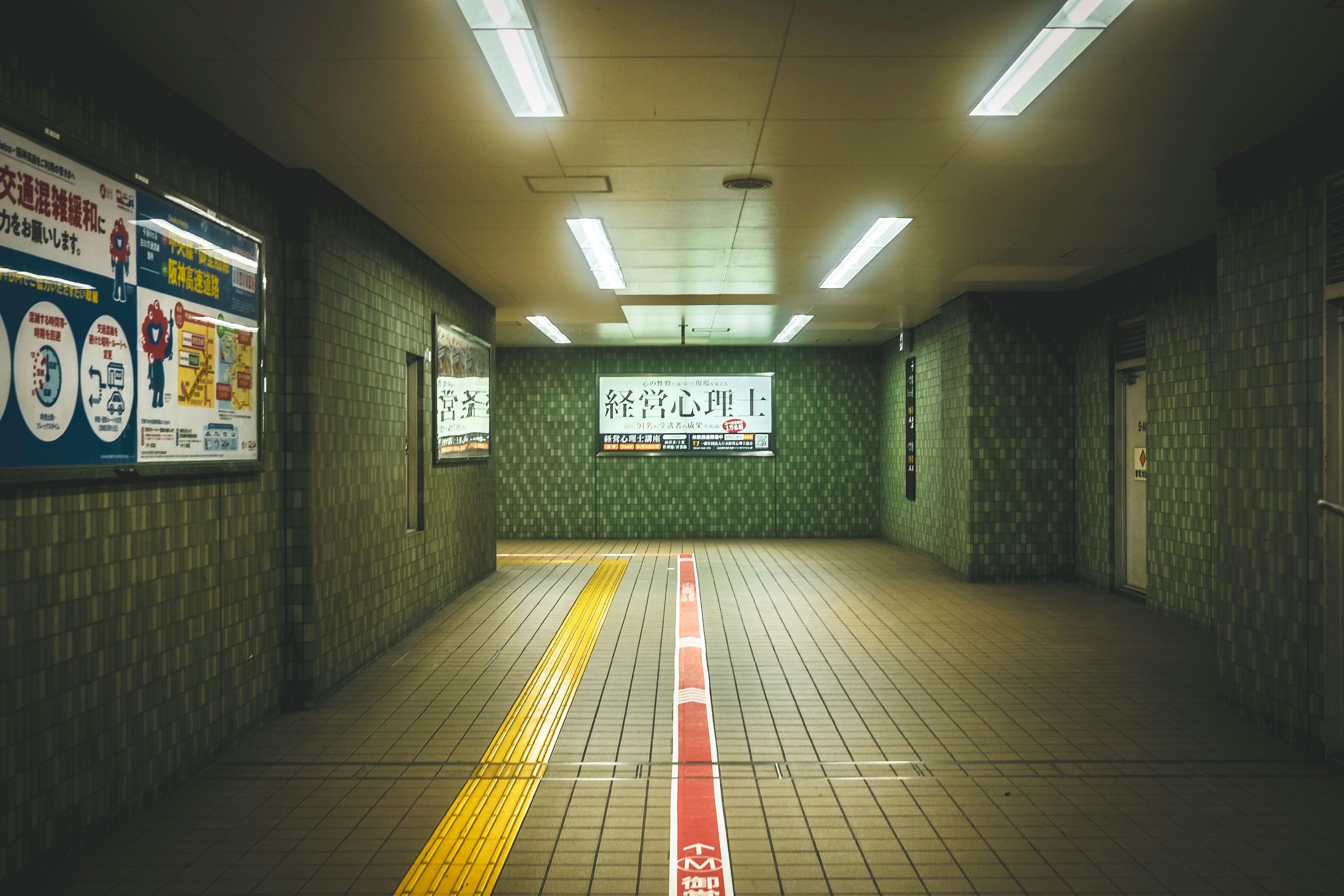 Empty Subway Station Hallway with Signs · Free Stock Photo