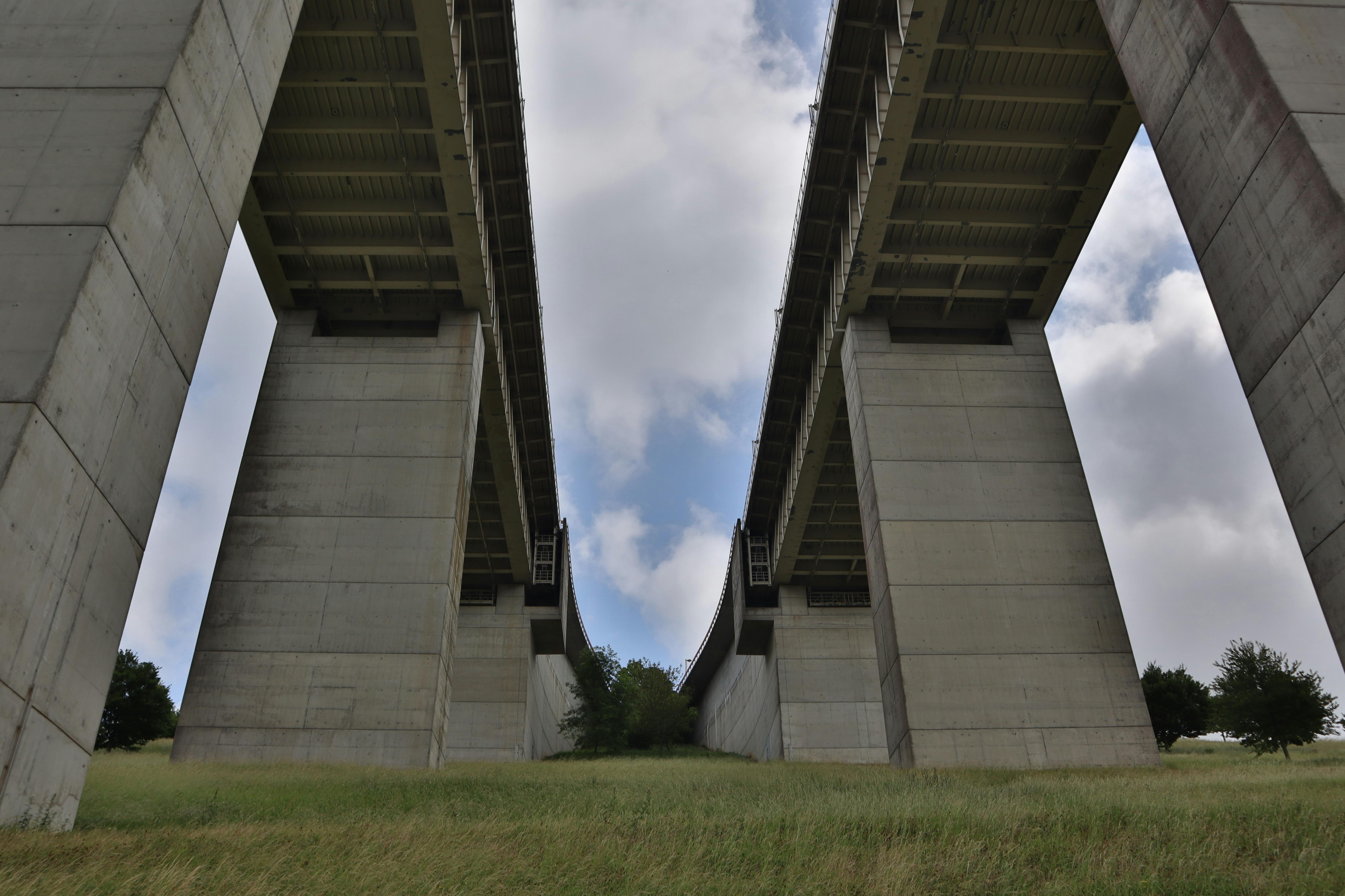Dramatic Underside View of Concrete Bridge Structure · Free Stock Photo