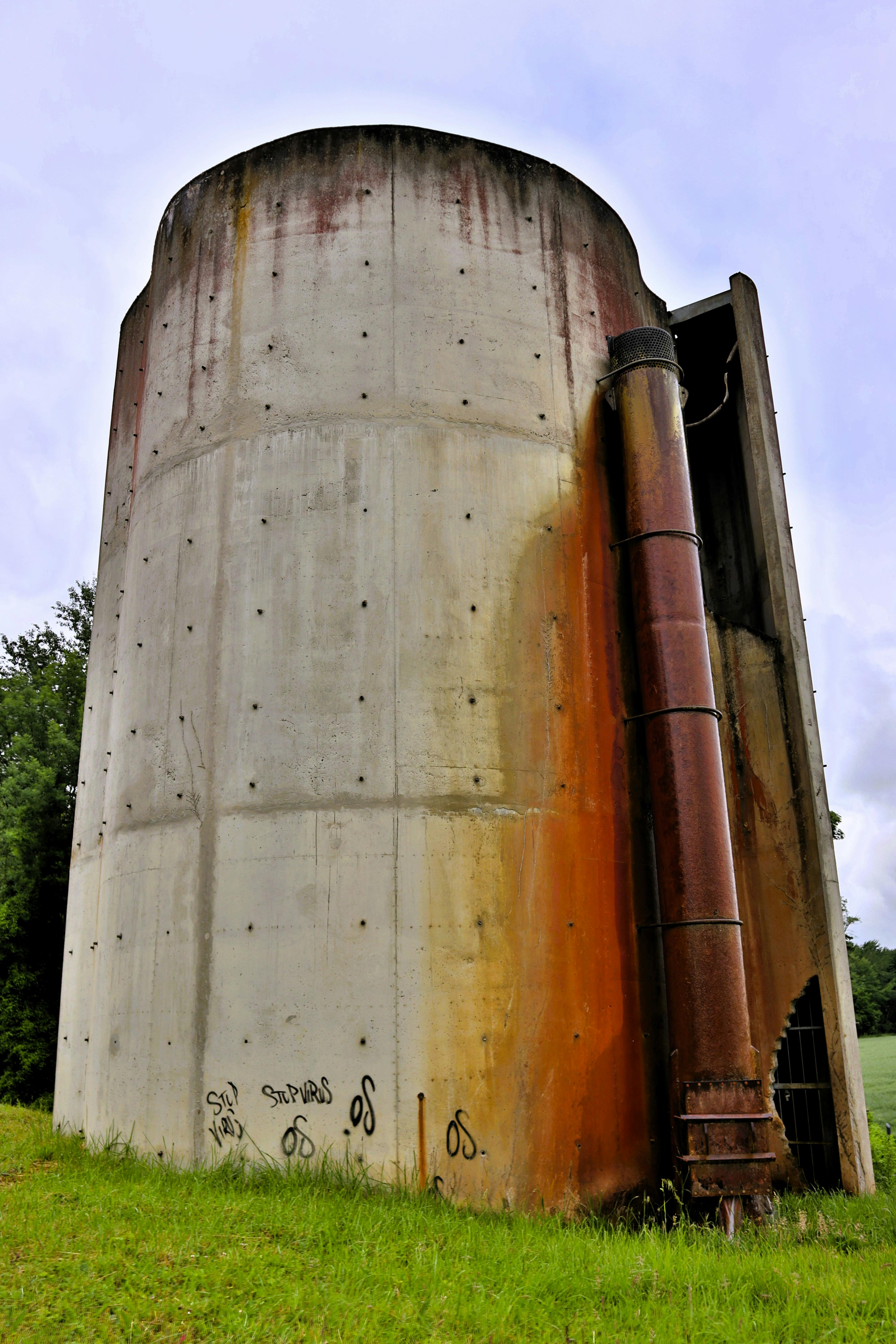 Concrete Silo with Rusty Metal Pipe in Nature · Free Stock Photo