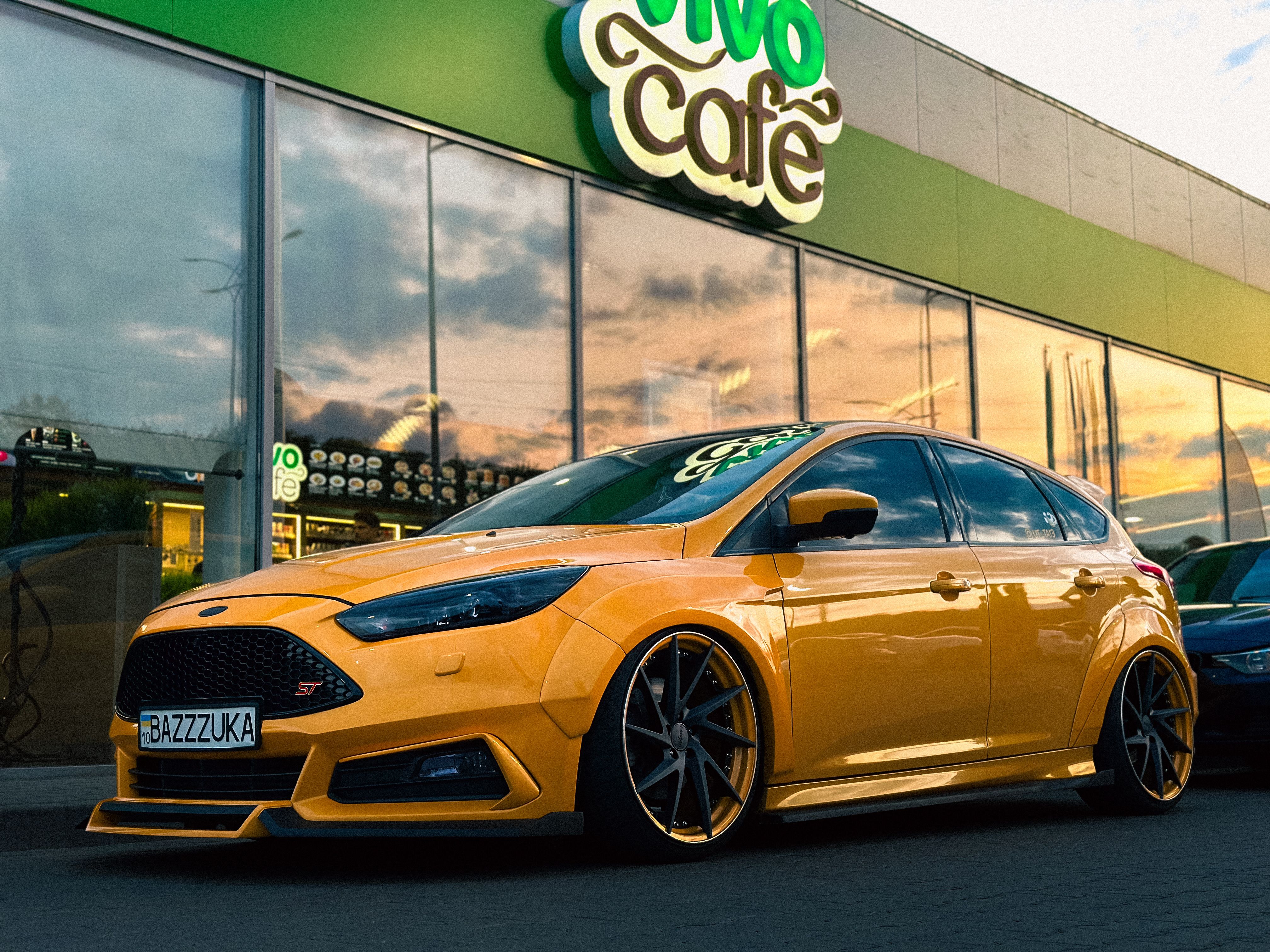 Striking Yellow Car in Front of Cafe at Sunset · Free Stock Photo