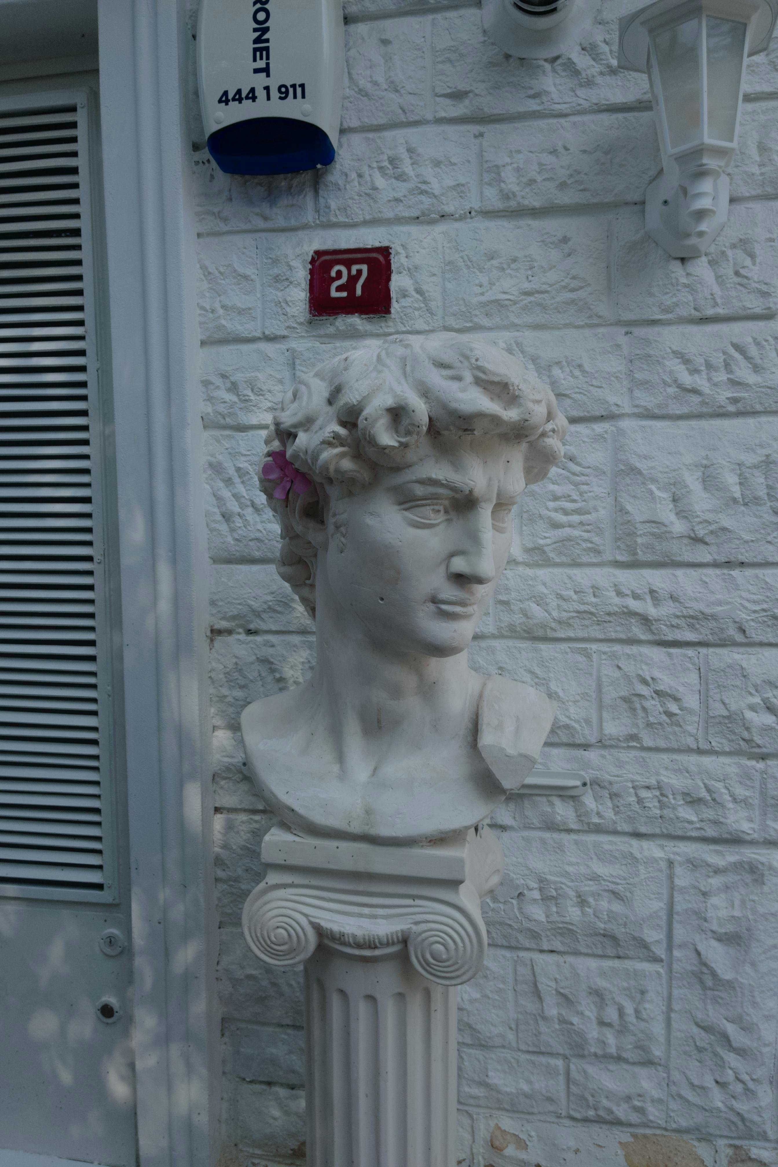 Bust of David Sculpture Against Brick Wall · Free Stock Photo