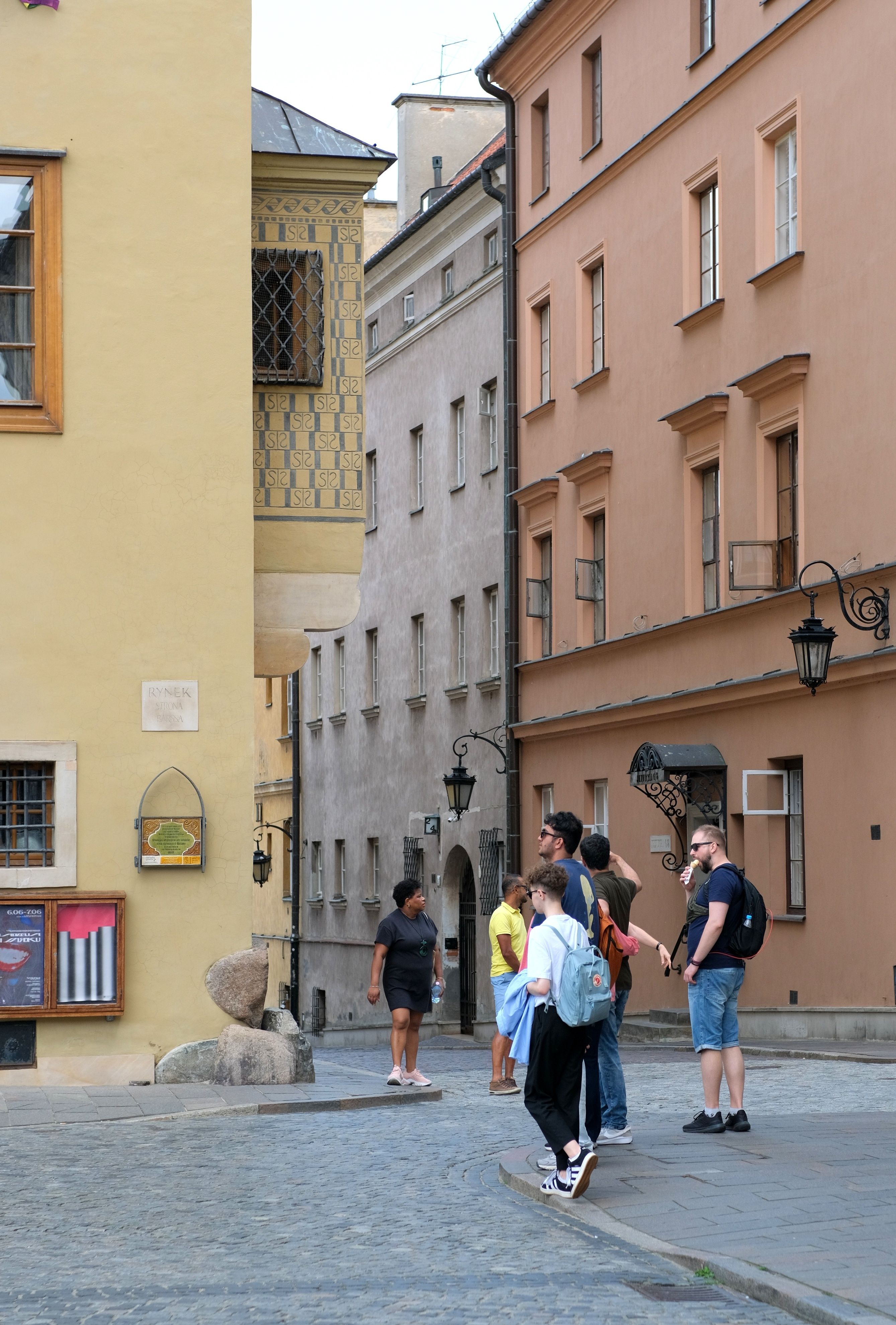 Tourists Exploring Historical European Street · Free Stock Photo