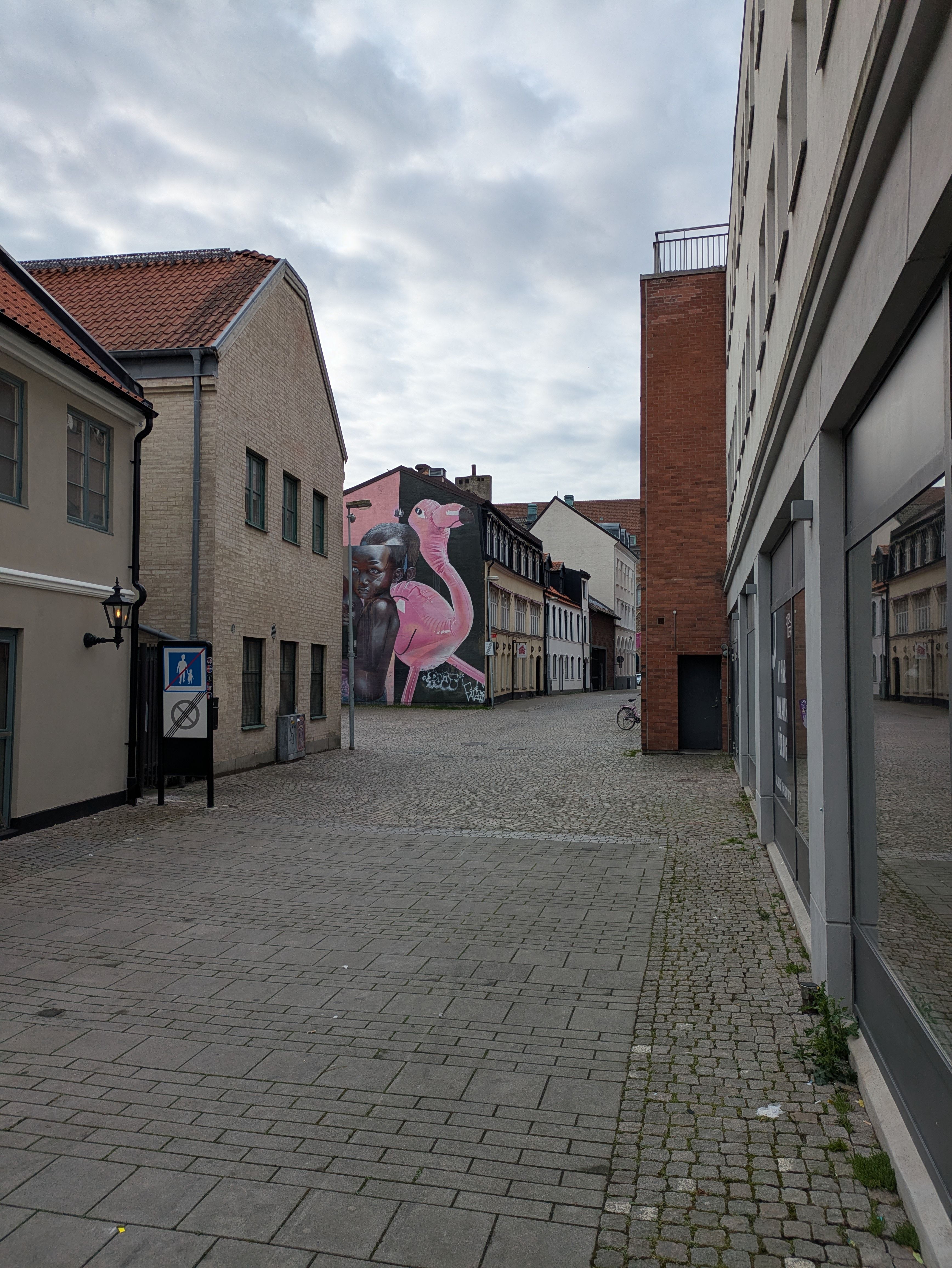 Quiet European street with vibrant mural · Free Stock Photo