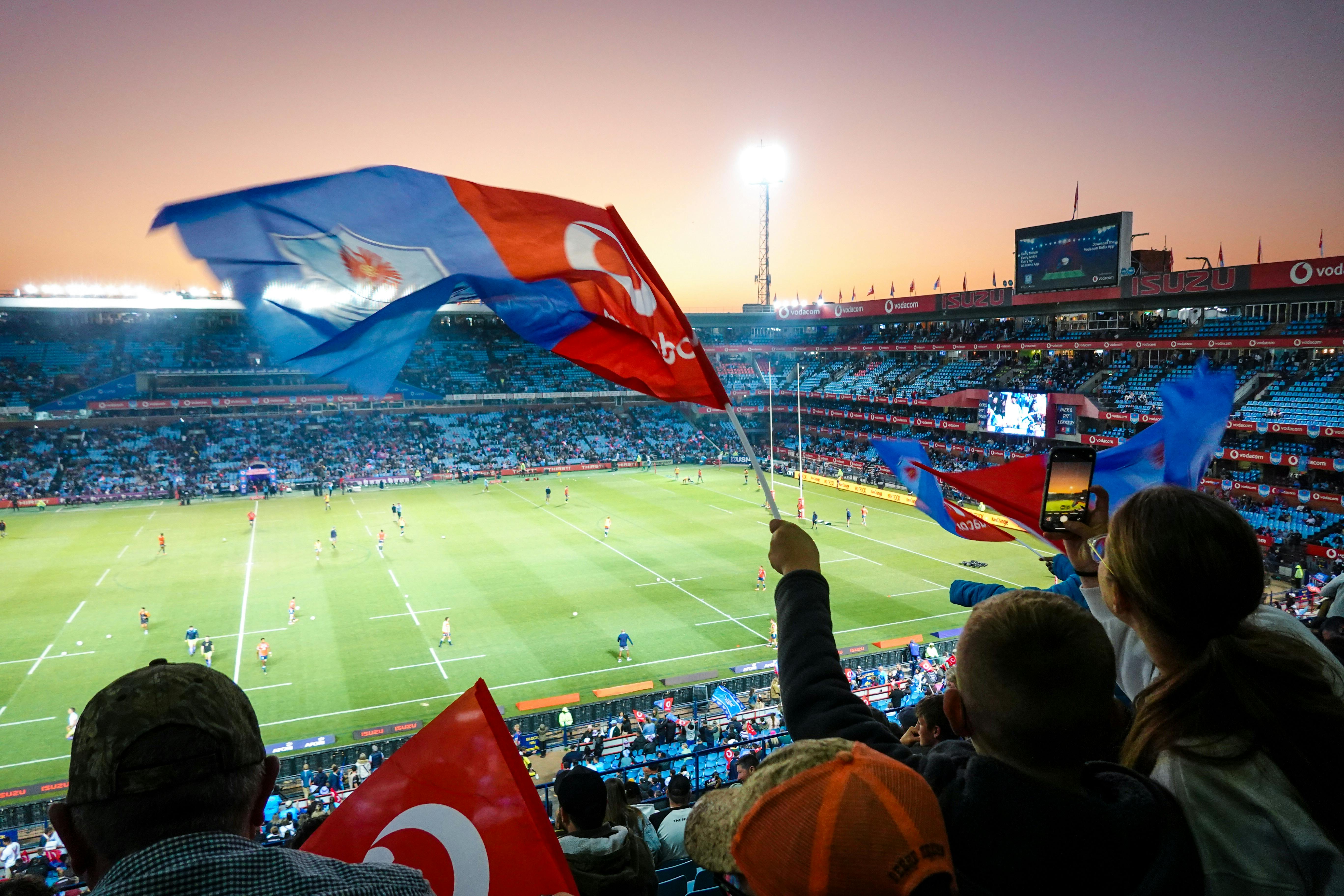 Vibrant Rugby Game at Large Stadium During Sunset · Free Stock Photo