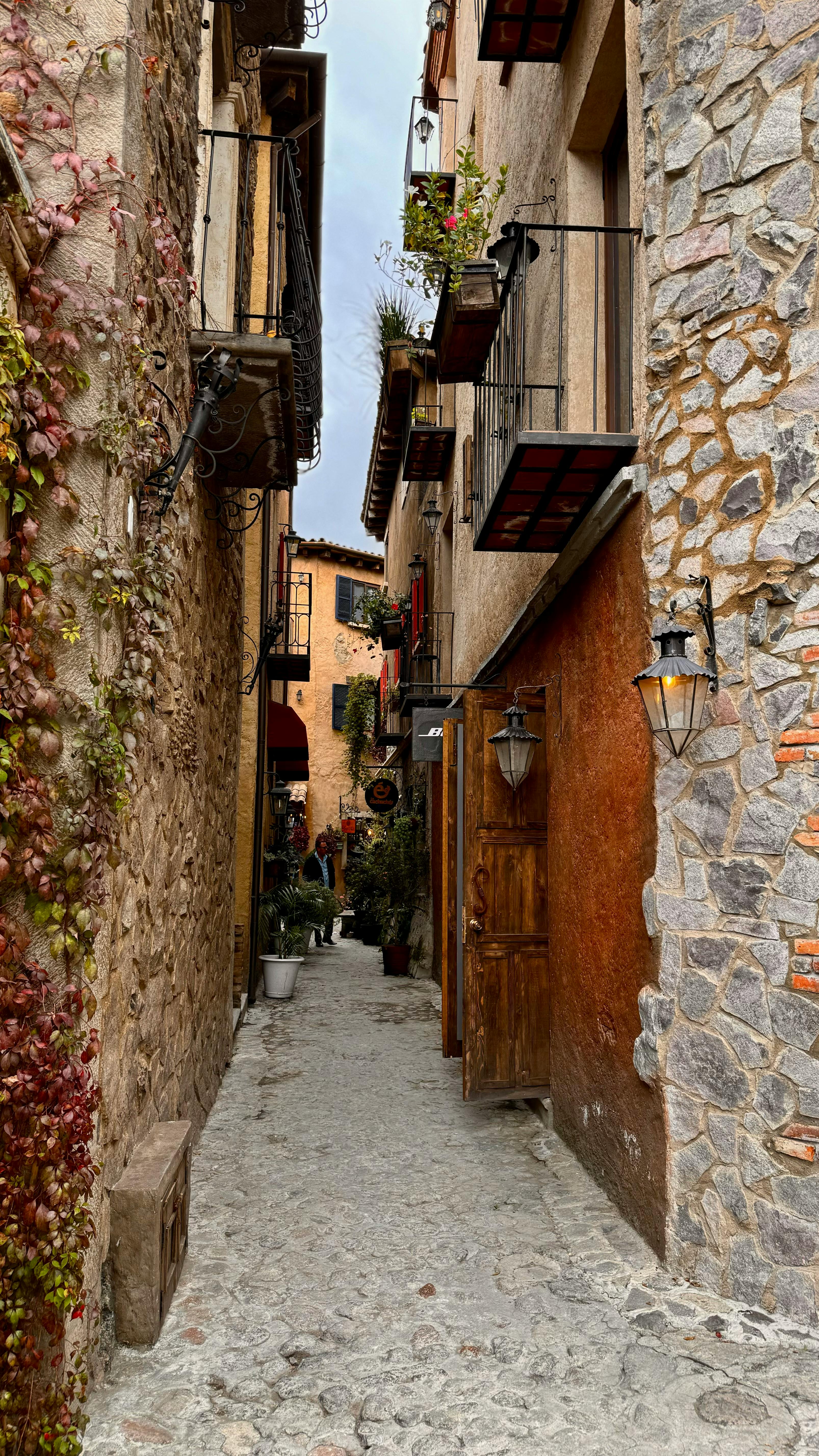 Charming Narrow European Alleyway with Rustic Walls · Free Stock Photo