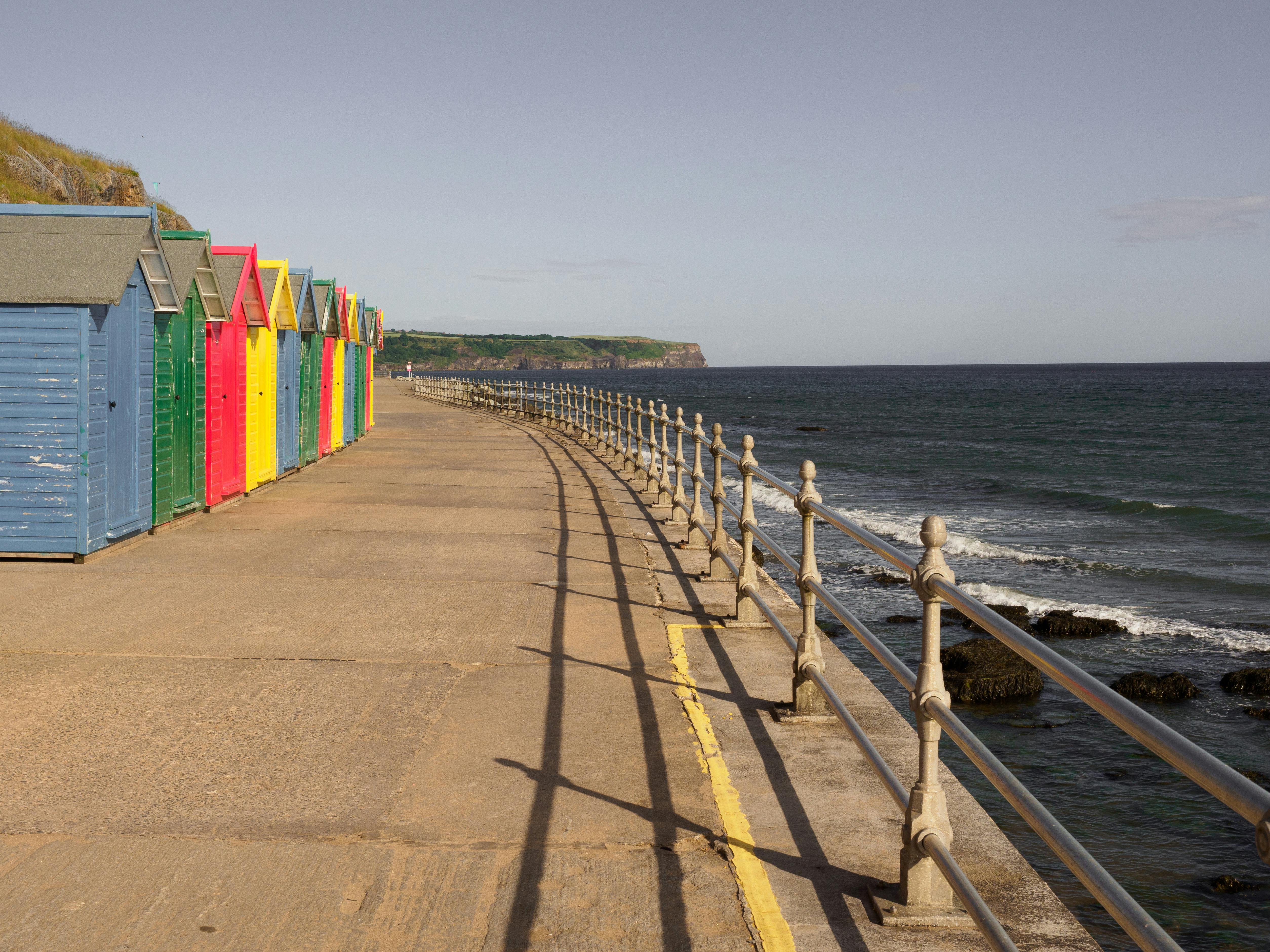 Colorful Beach Huts Along Whitby Promenade · Free Stock Photo