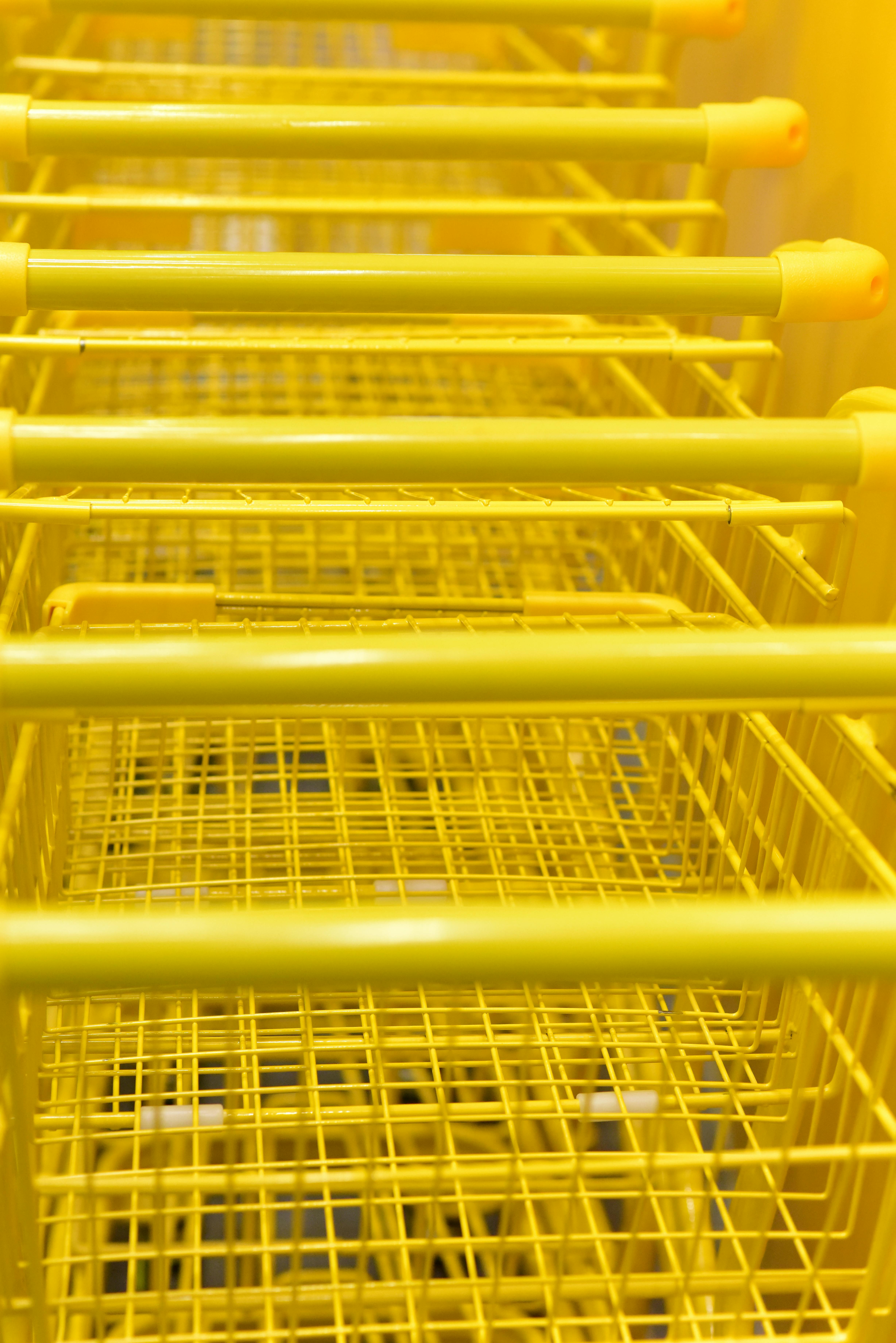 Bold Yellow Shopping Carts in Geometric Arrangement · Free Stock Photo