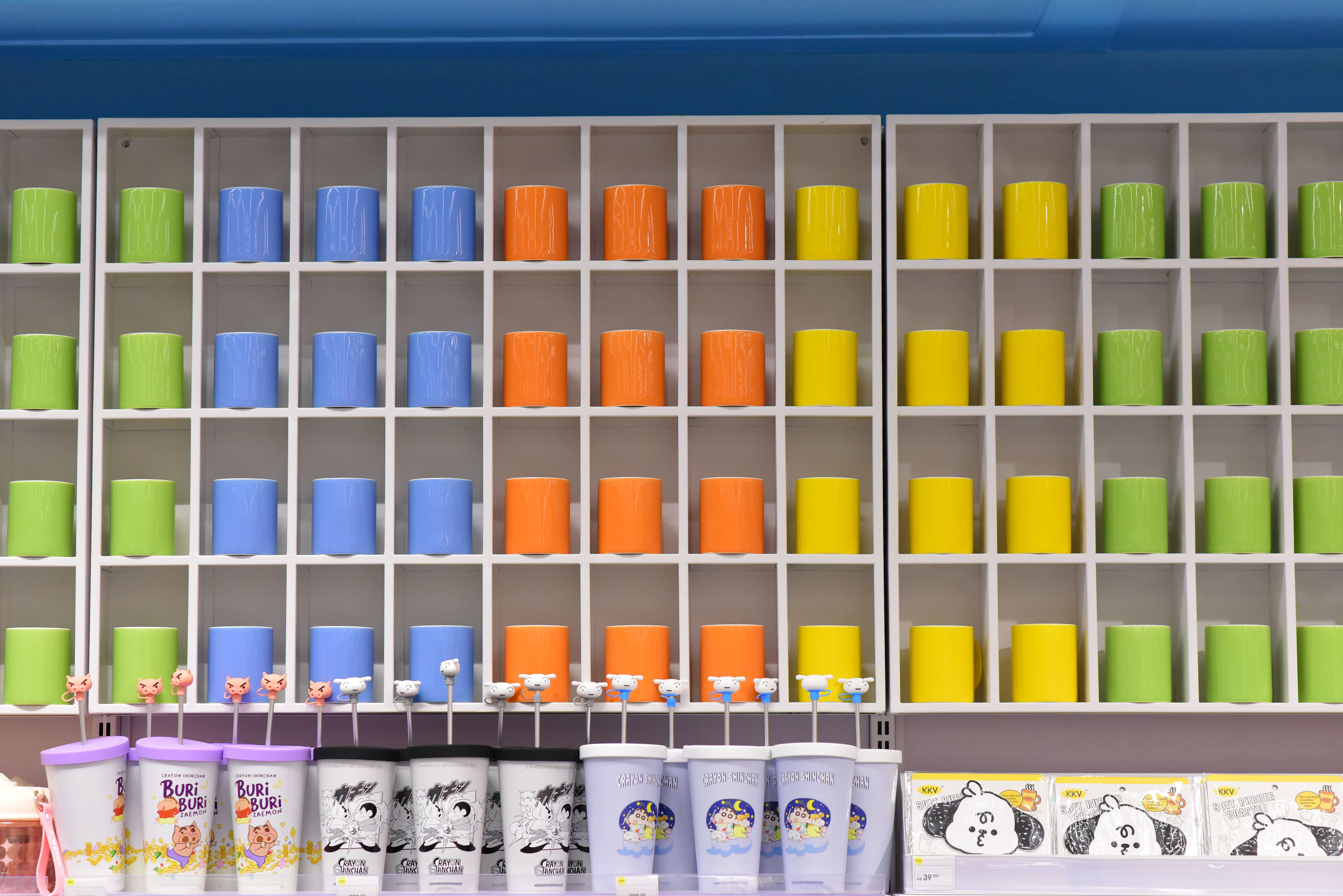 Colorful Shelf Display of Cups in a Store · Free Stock Photo
