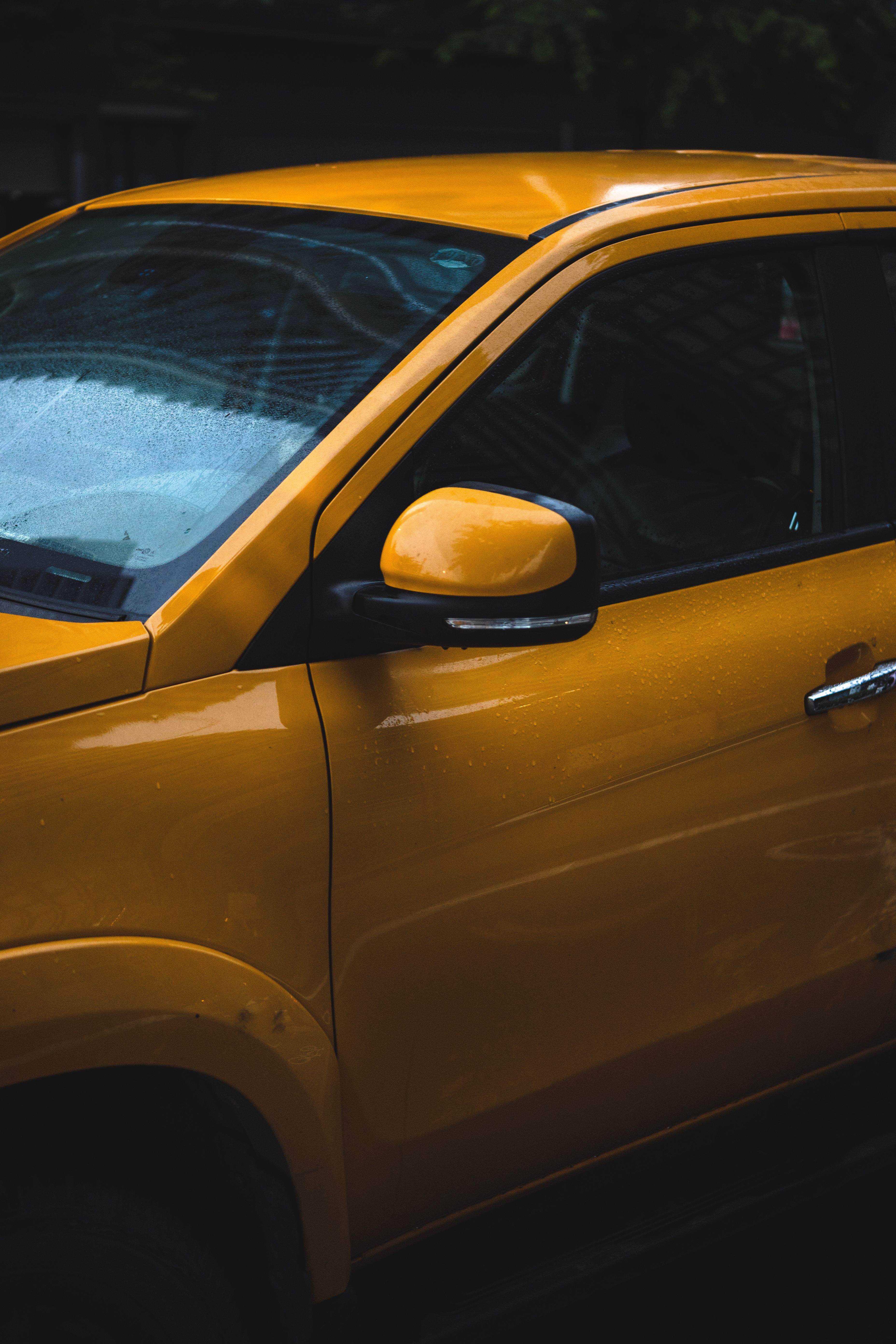 Close-Up of a Yellow Car in Moody Lighting · Free Stock Photo