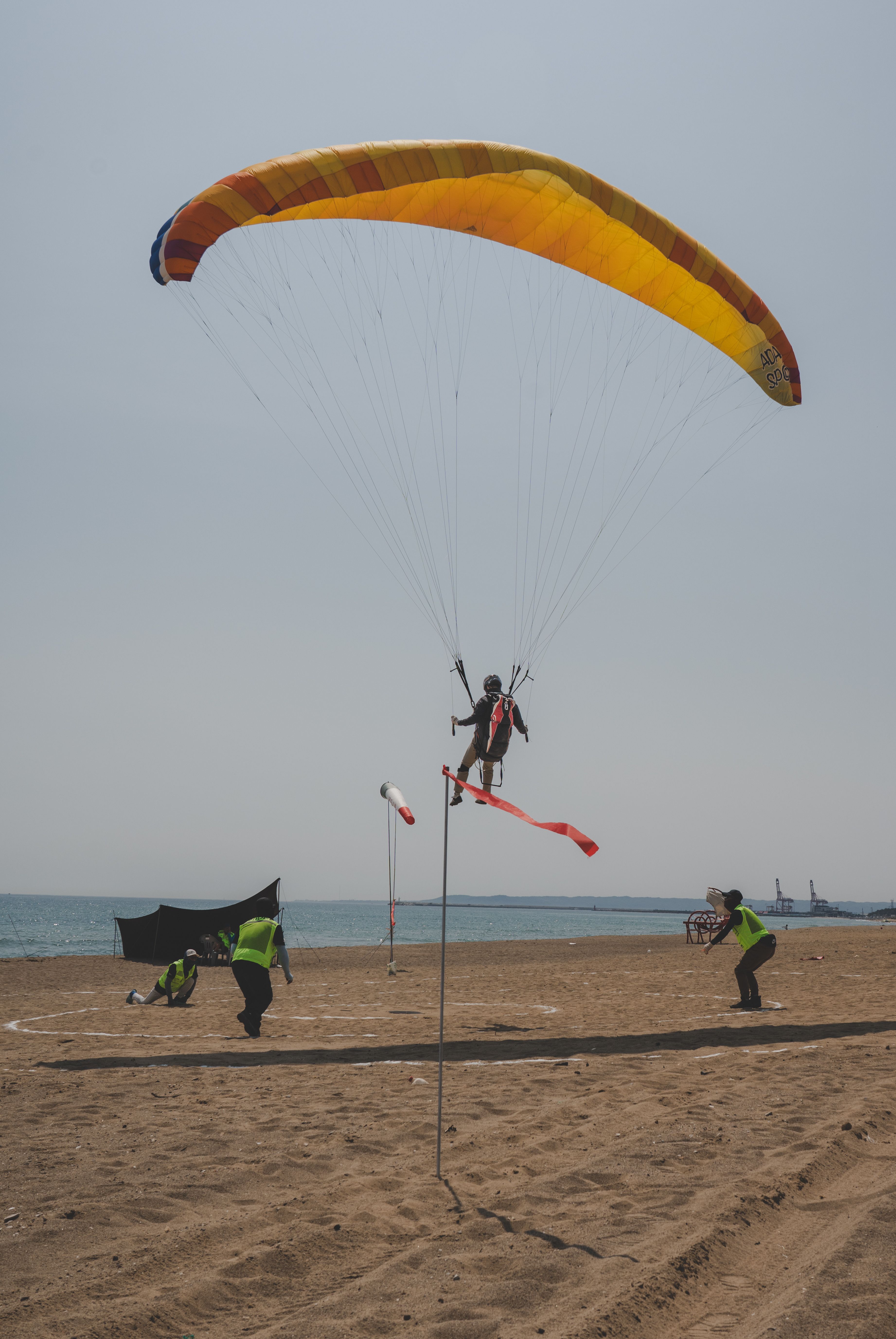 Exciting Beach Paragliding Landing Capture · Free Stock Photo